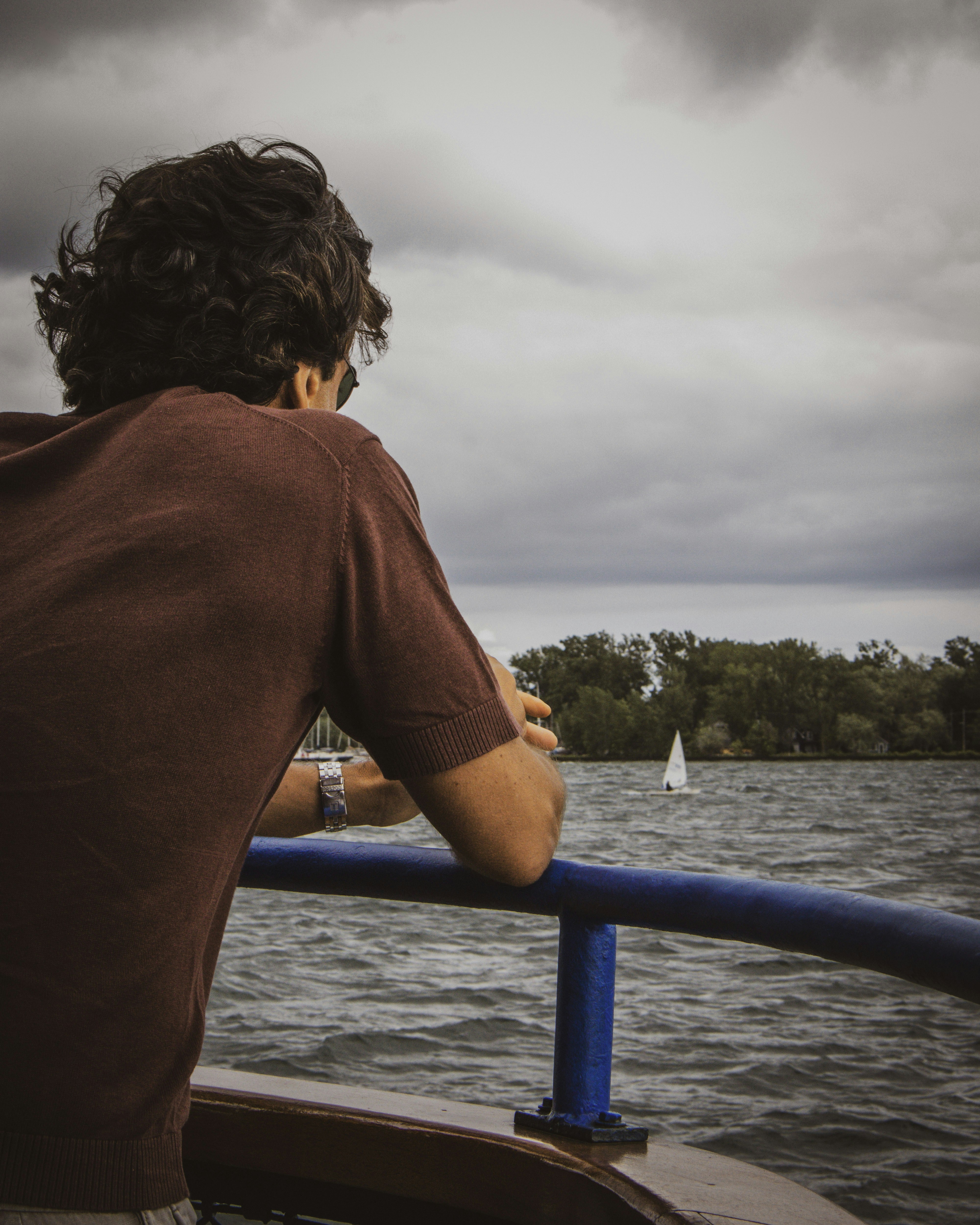 Horizon Gazer at the Railing: Quiet Moment by the Lake