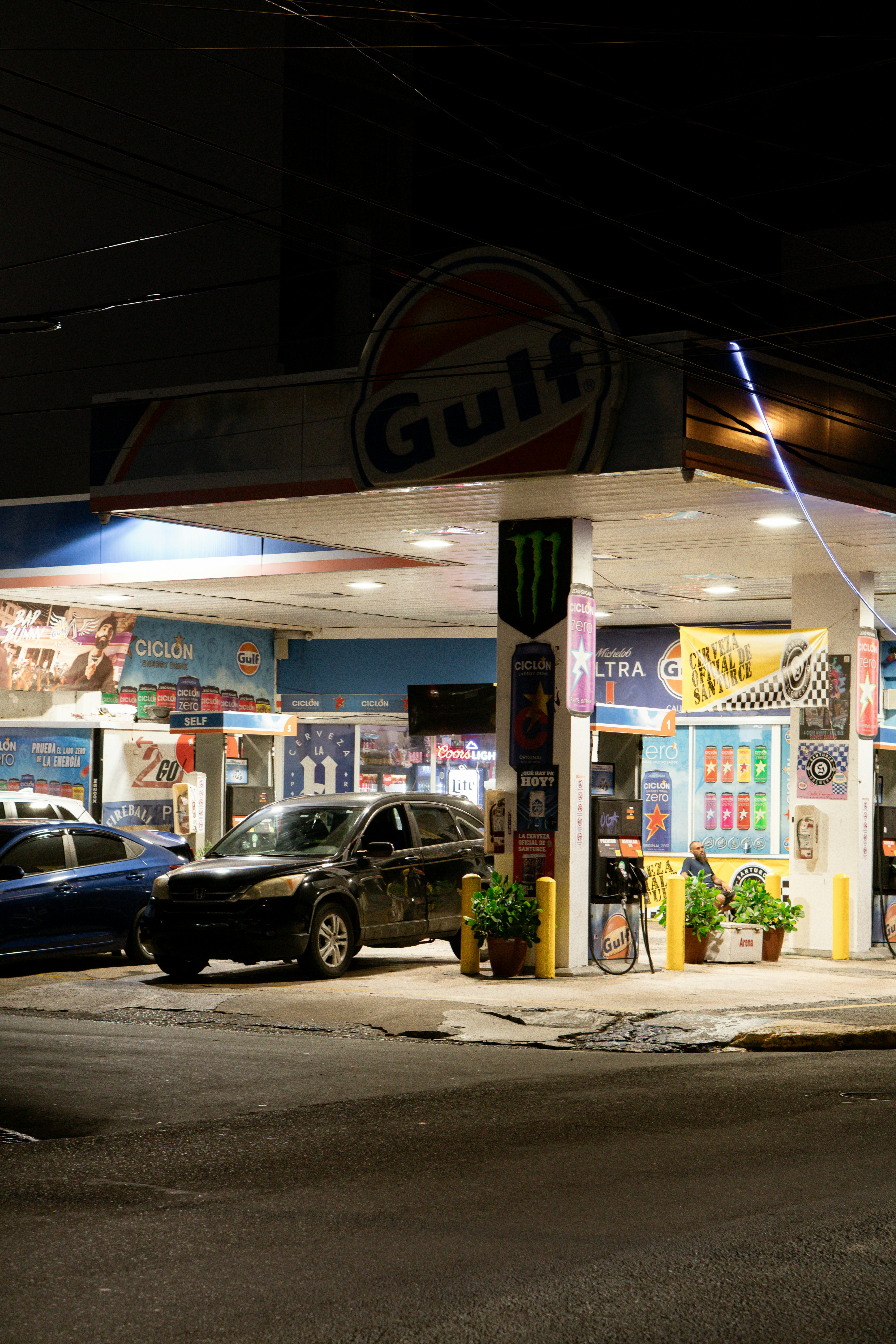 Neon Gulf at Night: Quiet Pumps and Reflective Asphalt