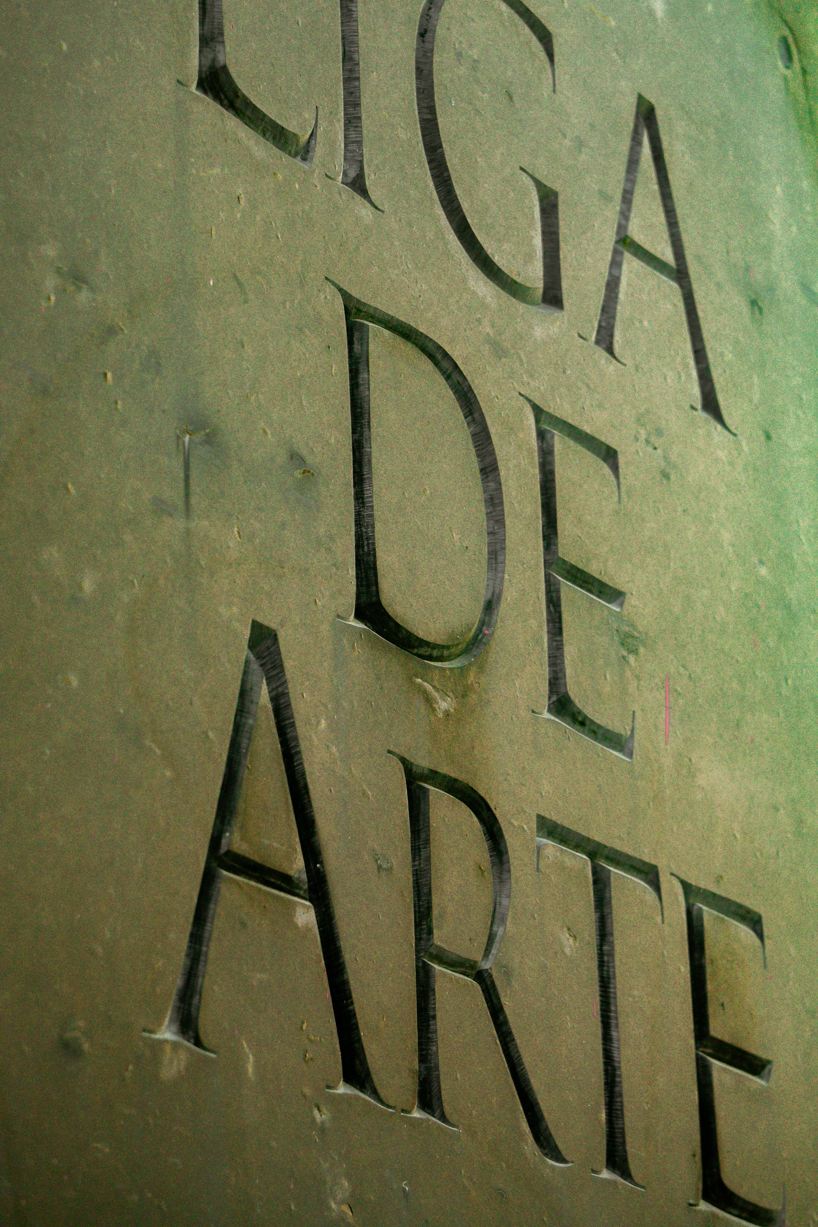 Patinated Metal Plaque with LIGA DE ARTE in Bold Carved Letters