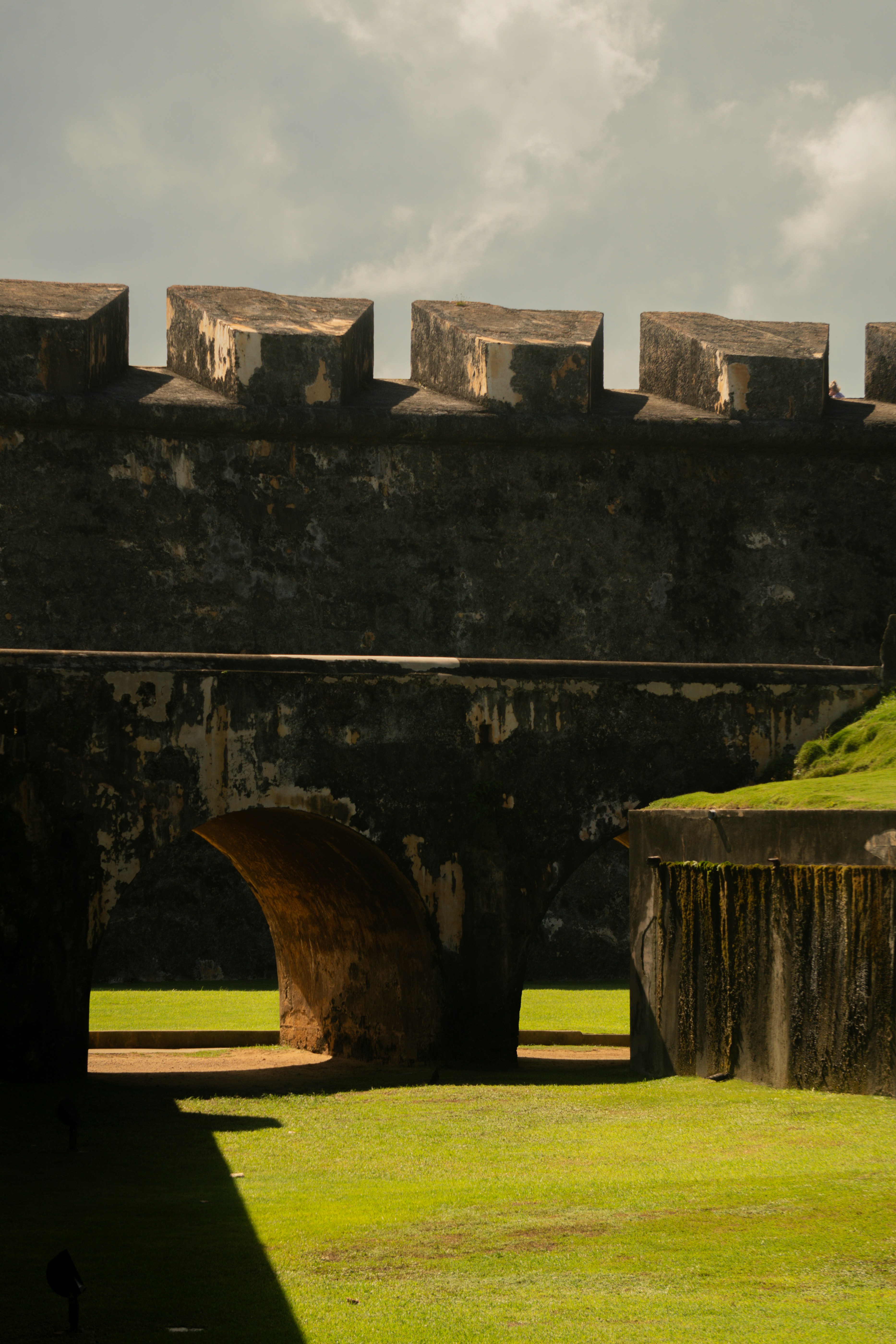 Sunlit Archway Beneath Weathered Ramparts