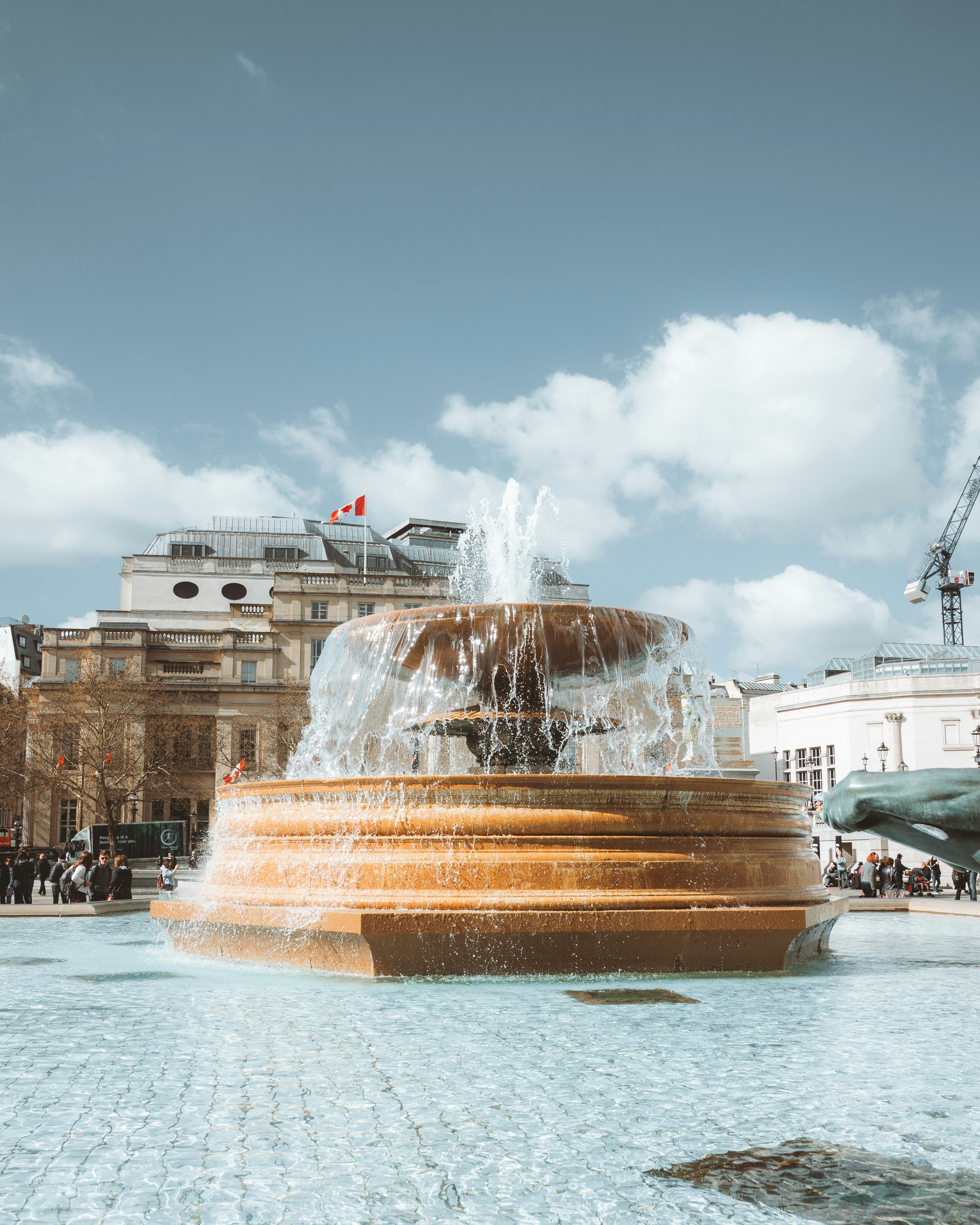 Copper Ring Cascade in a Sunlit City Square
