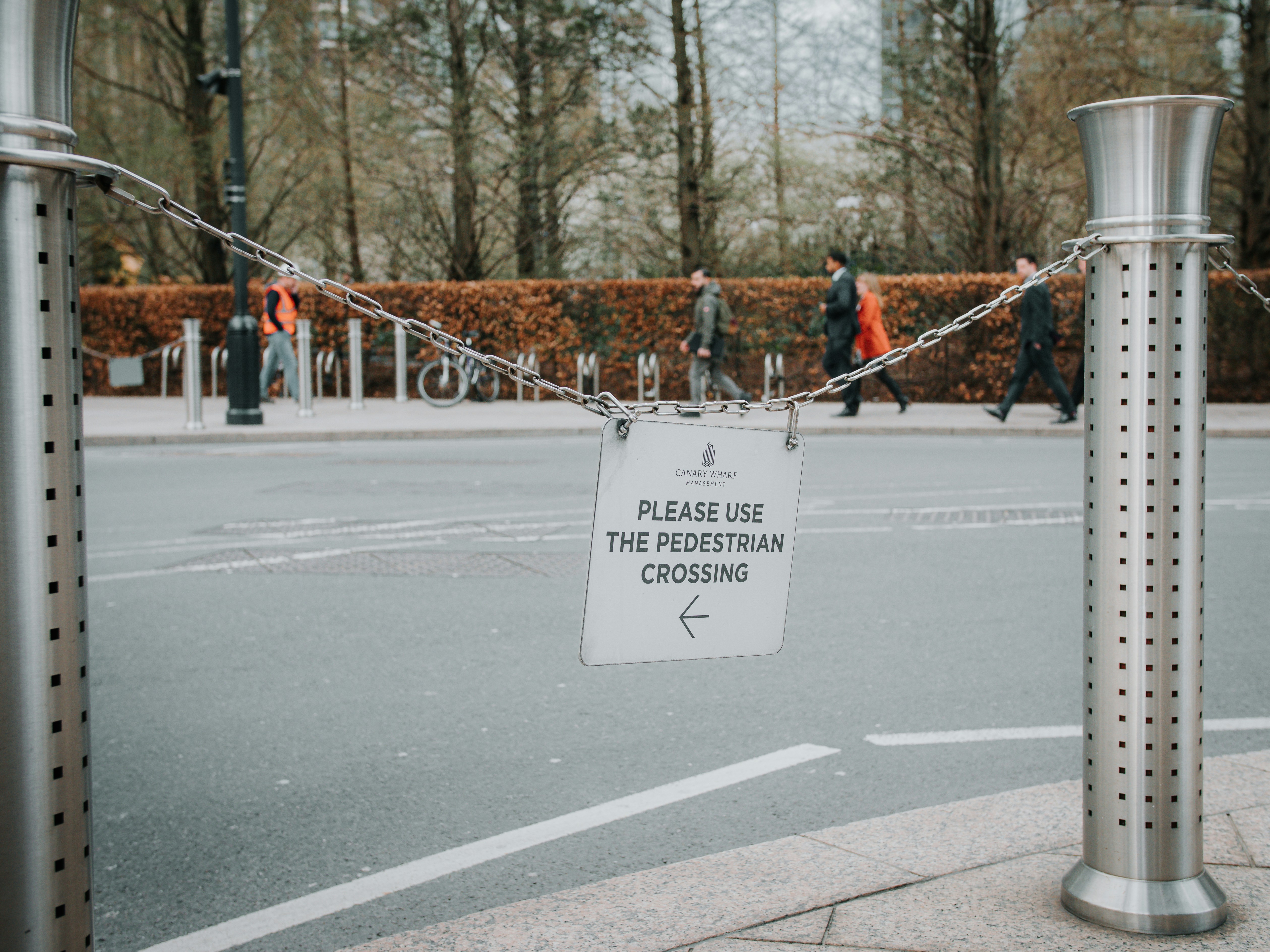 Between Steel Pillars: The Pedestrian Crossing Sign in Quiet Pause