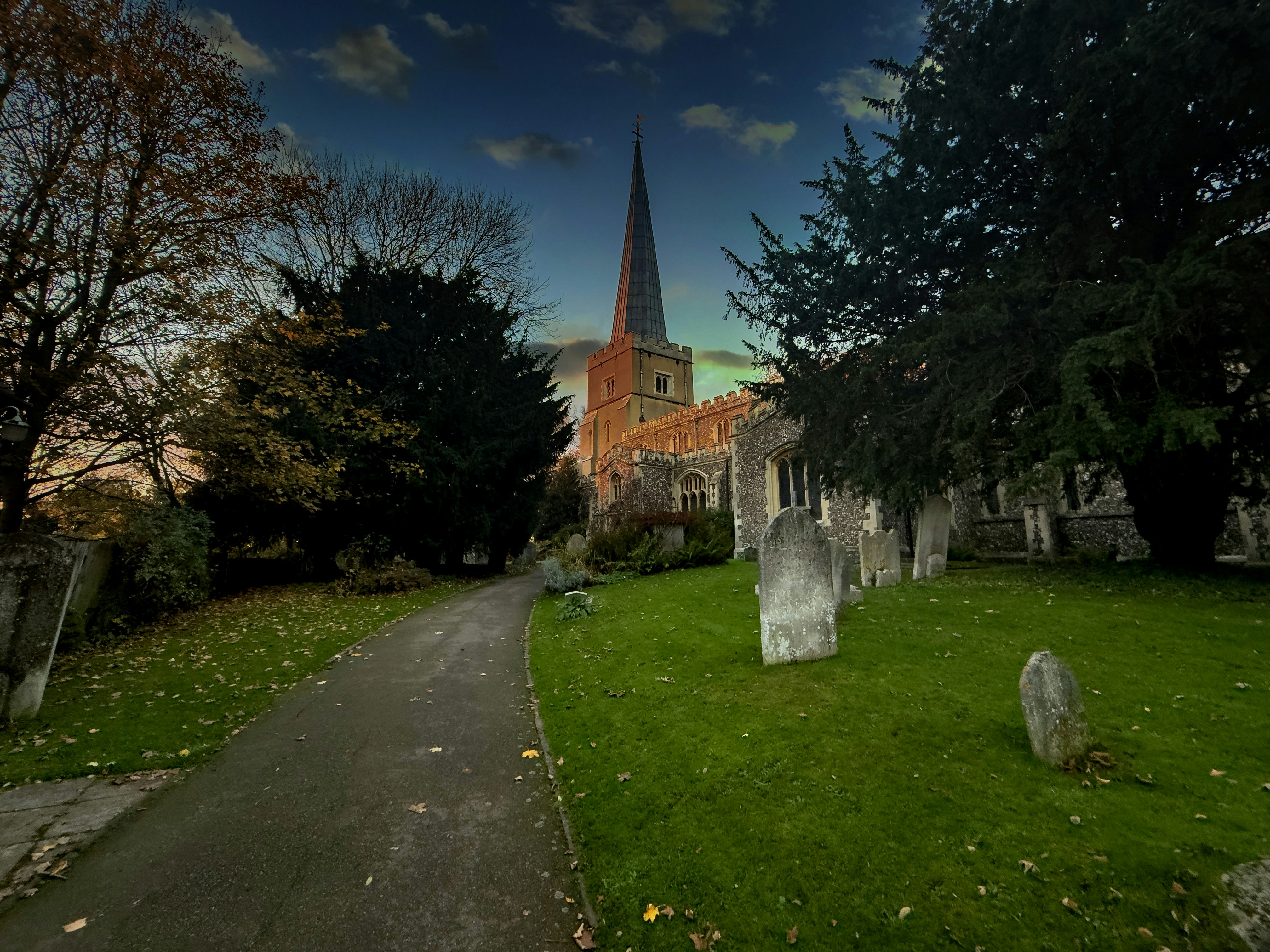 Twilight Spire Over a Quiet Churchyard Path