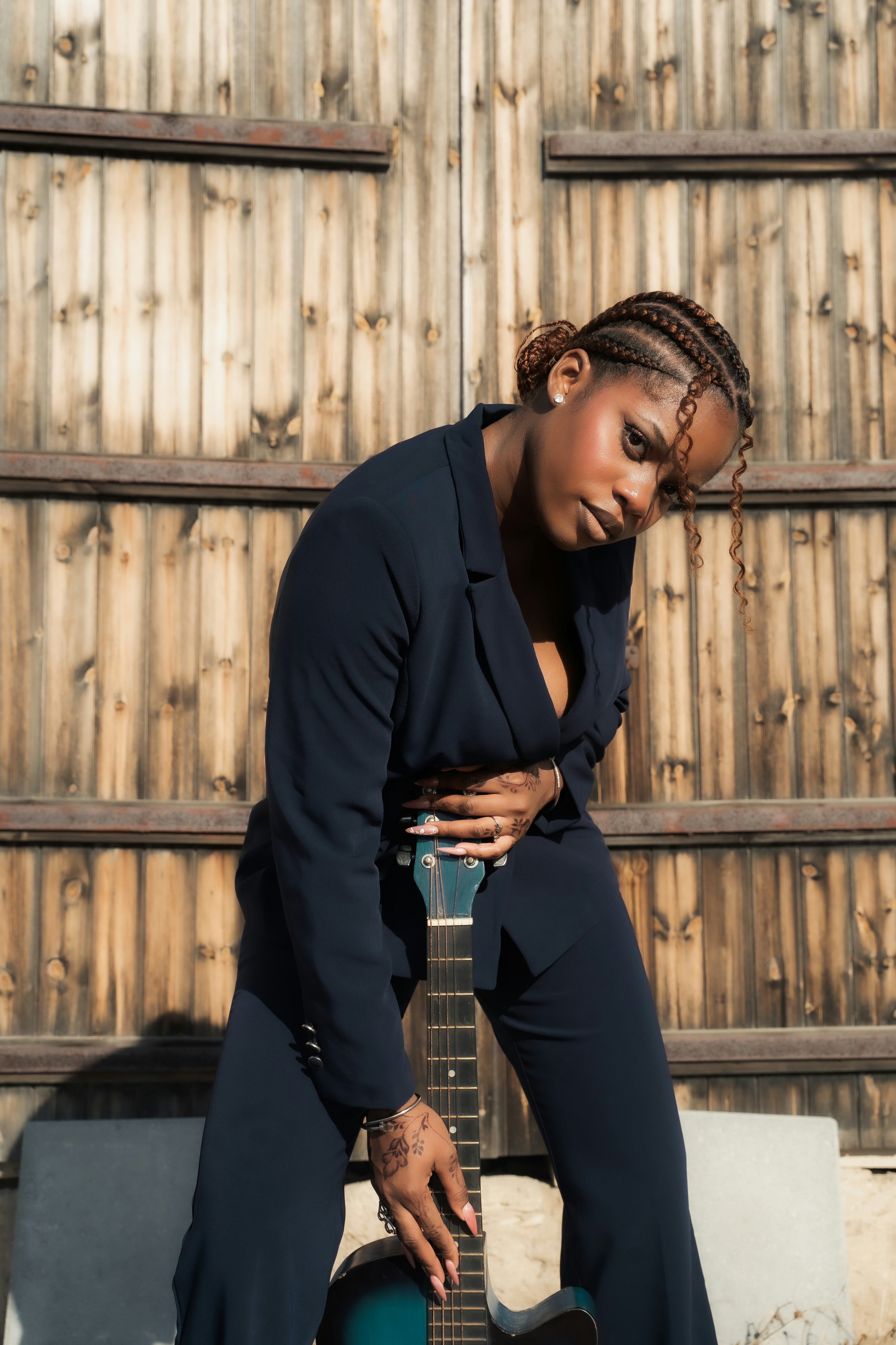 Navy Attire, Quiet Strings: A poised portrait by weathered timber.