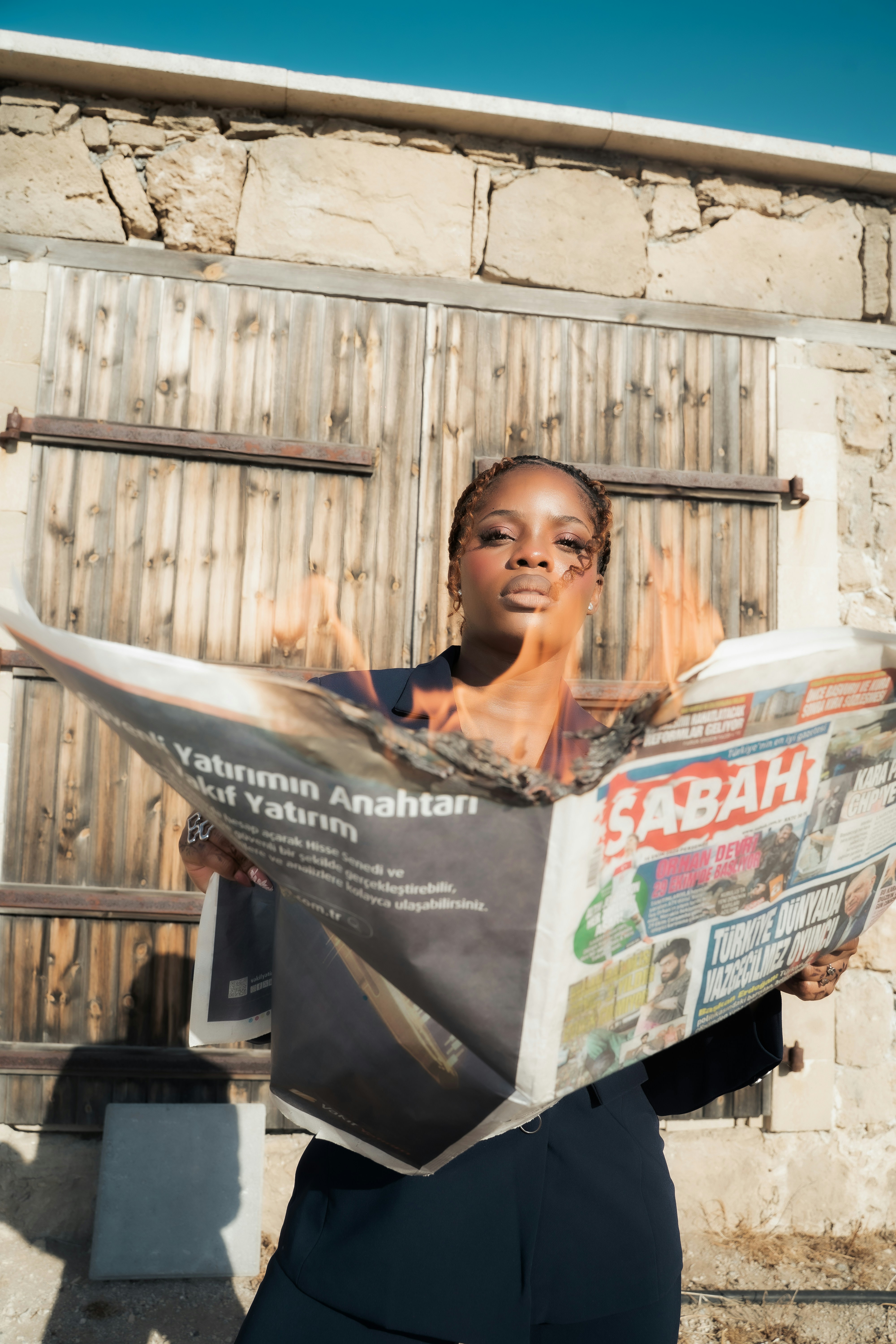 Sunlit Focus: Reading the News by a Weathered Door