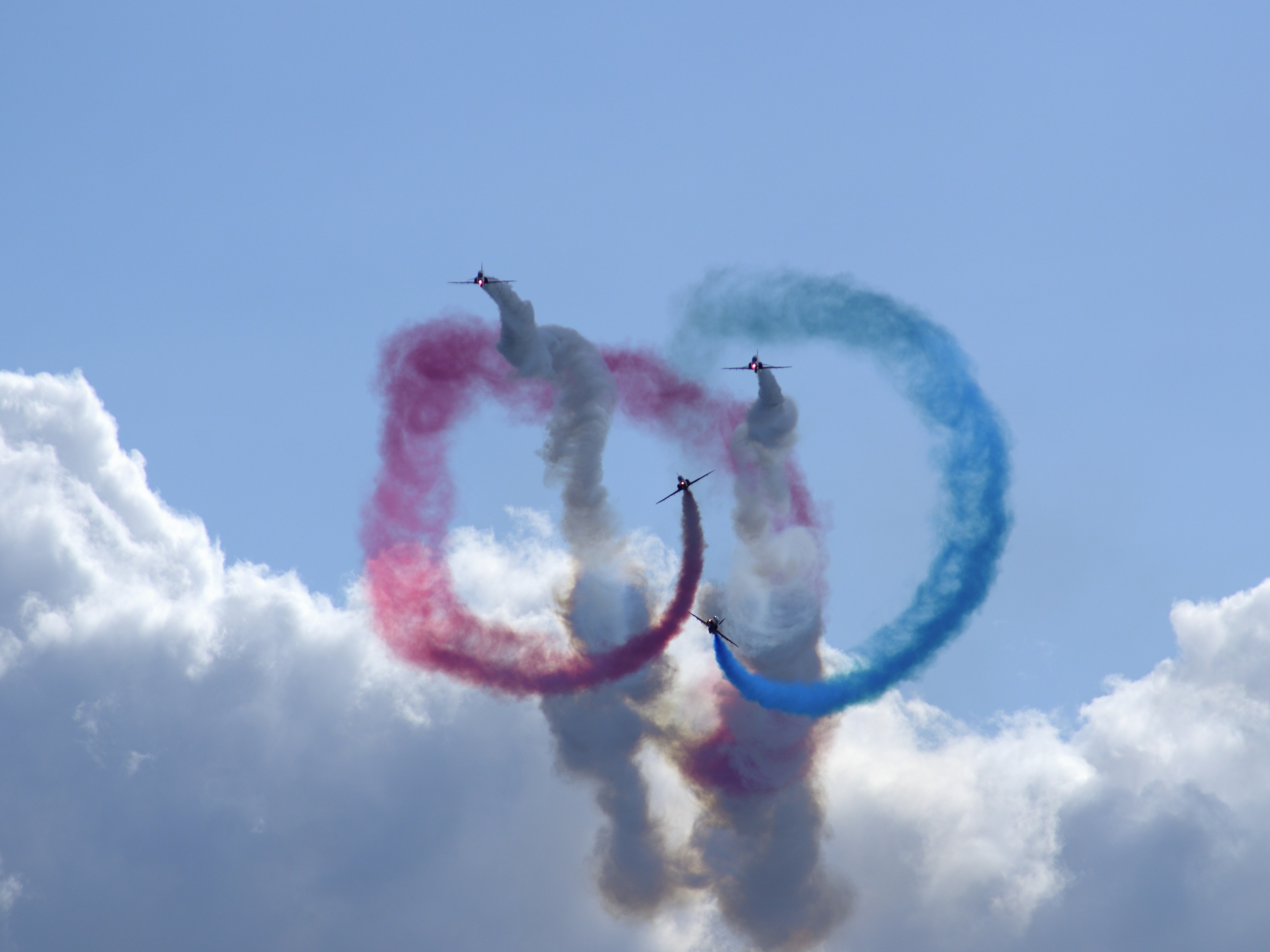 Triple Color Rings: Synchronized Aerial Smoke Loops Over a Clear Sky