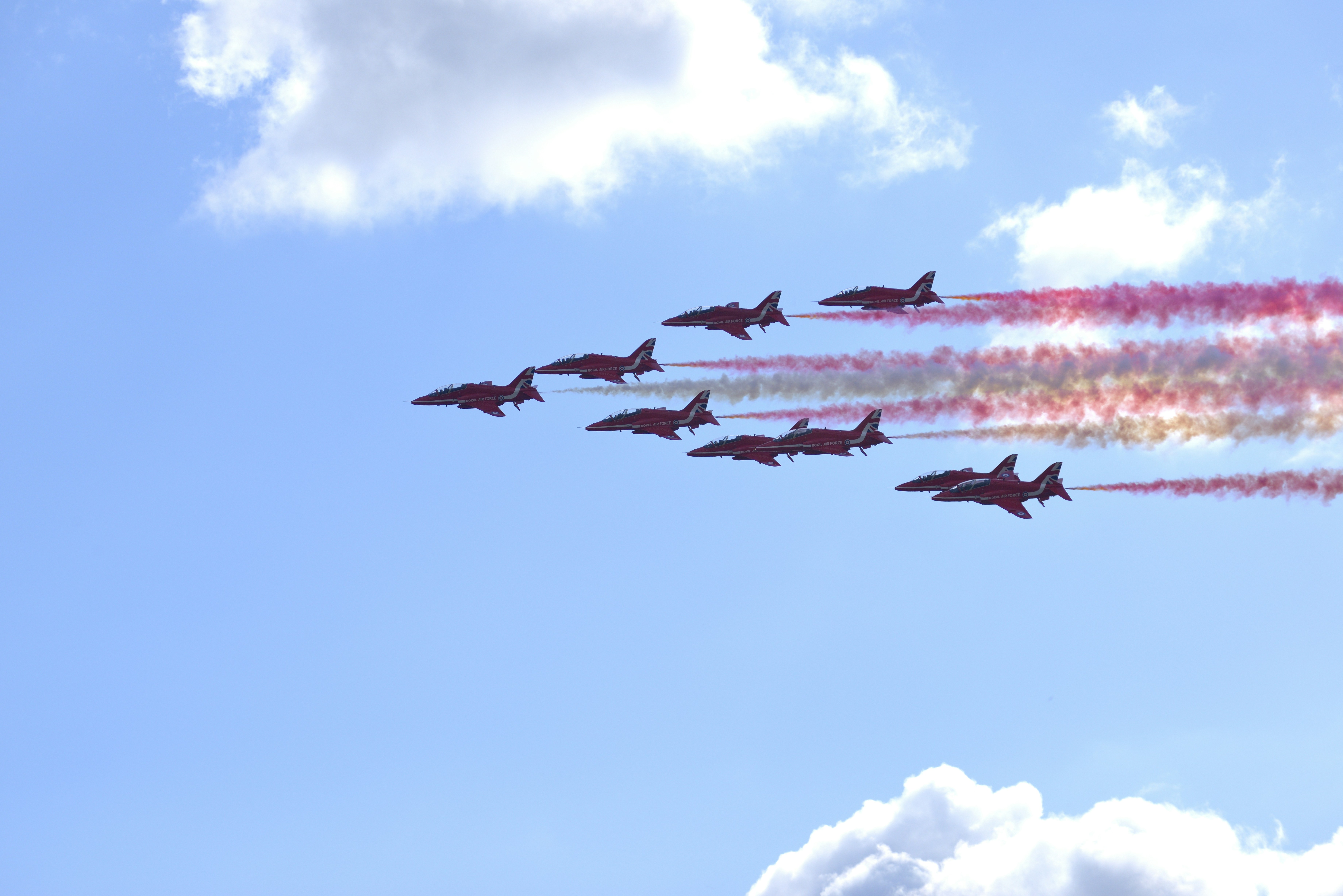 Red Smoke Jet Formation Across a Cerulean Sky