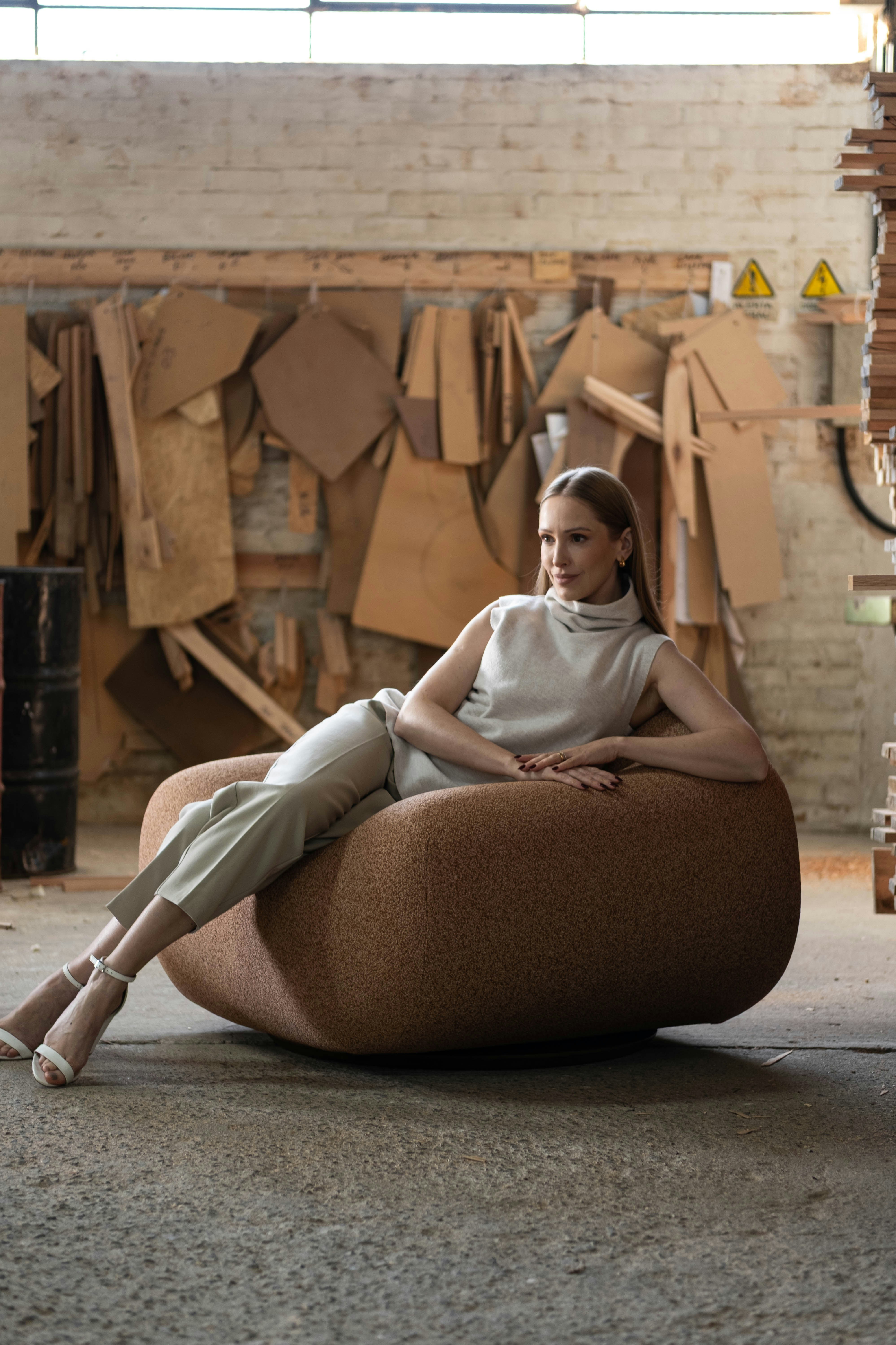 Calm Among Cardboard: A Portrait on a Sculptural Sofa