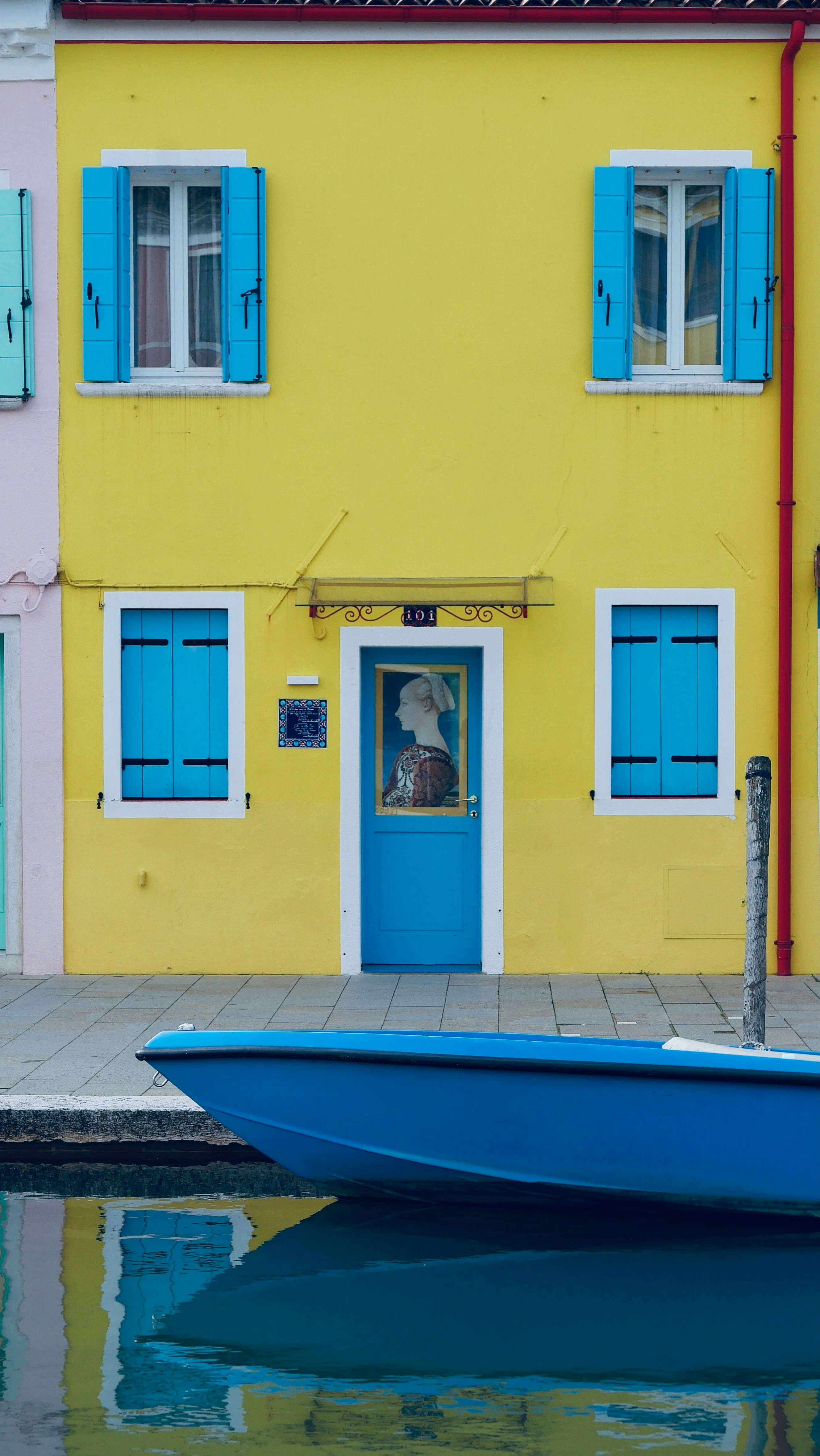 Yellow Facade, Electric Blue: A Canal House Beside the Quiet Water