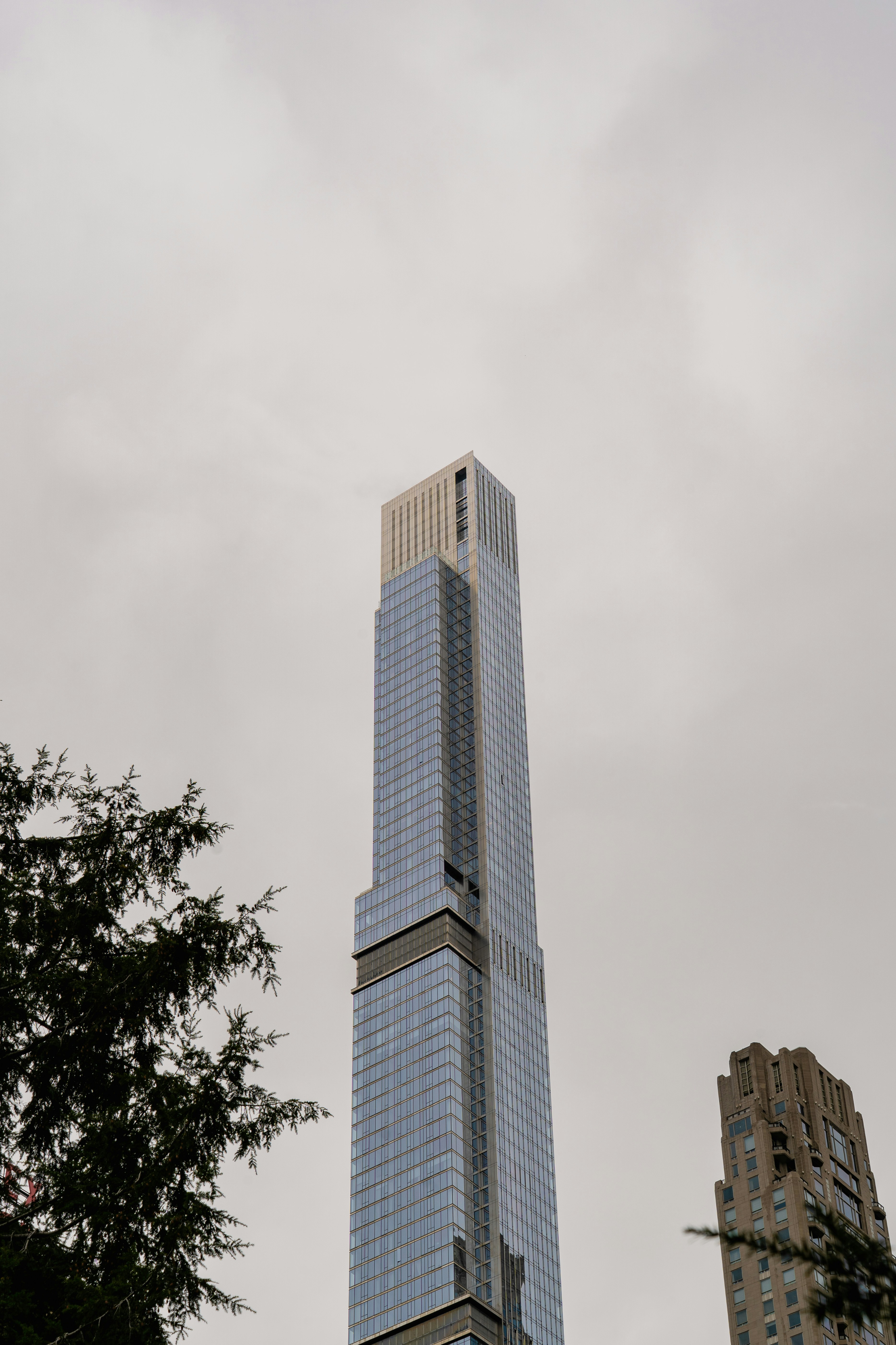 Vertical Prism: The Skyward Glass Spire Amid a City Skyline