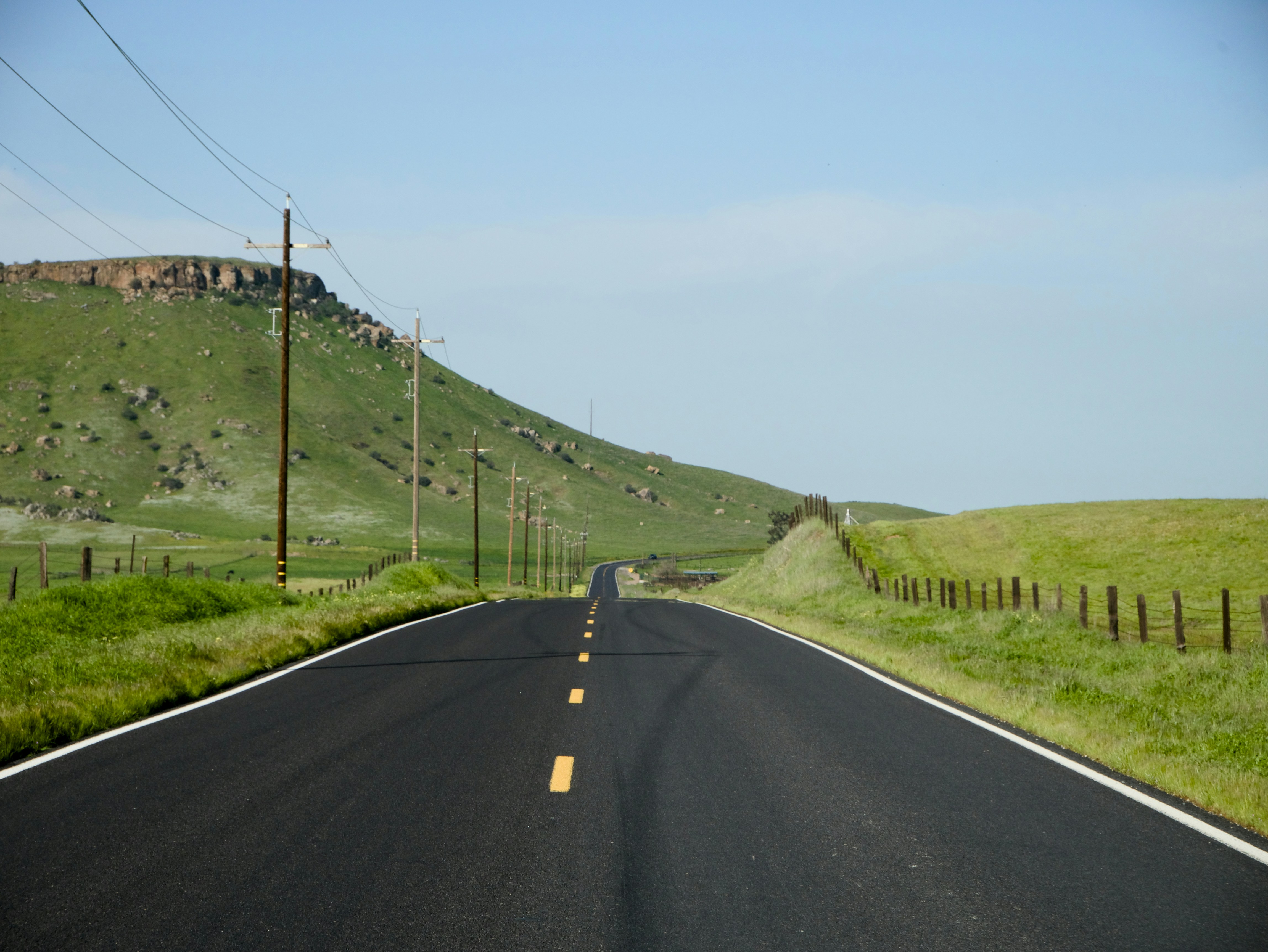 Toward the Quiet Vanishing Point: A Road Through Green Hills