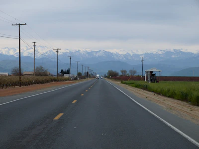 Road to the Snow-Kissed Horizon: A Quiet Highway Toward the Mountains
