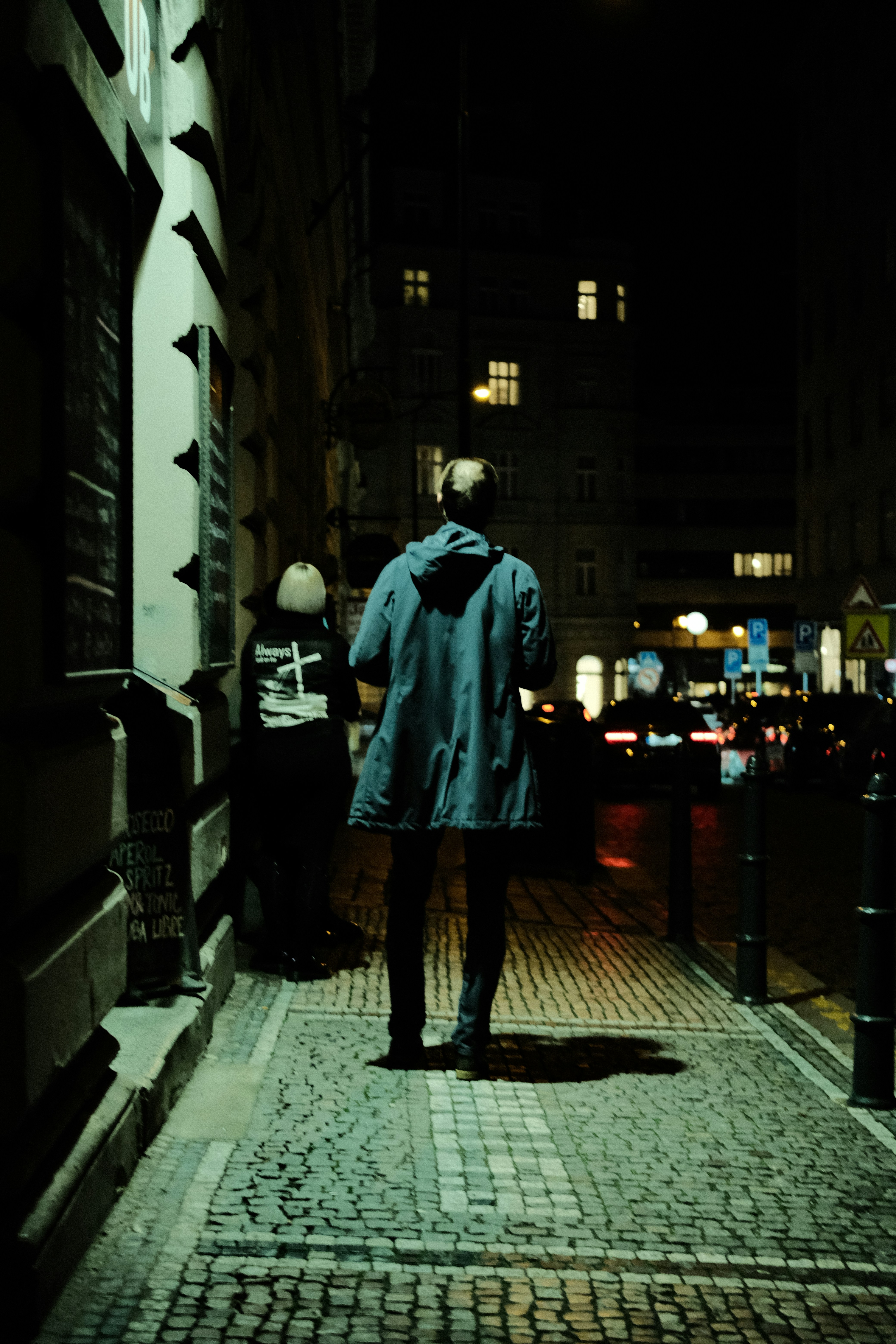 Person in the lamp light on city street at night