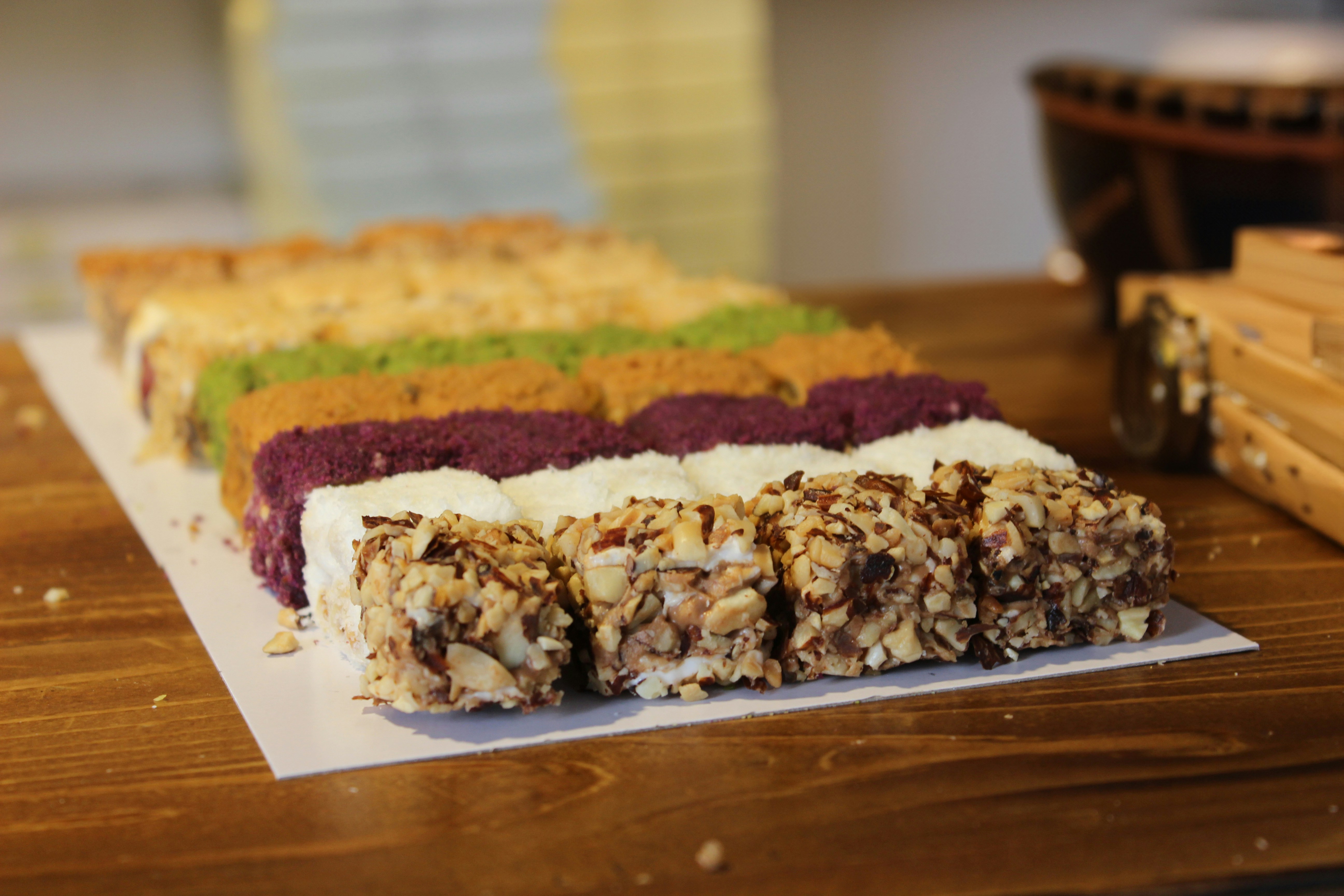 Nut-Crusted Rainbow Bars on a Rustic Wooden Counter