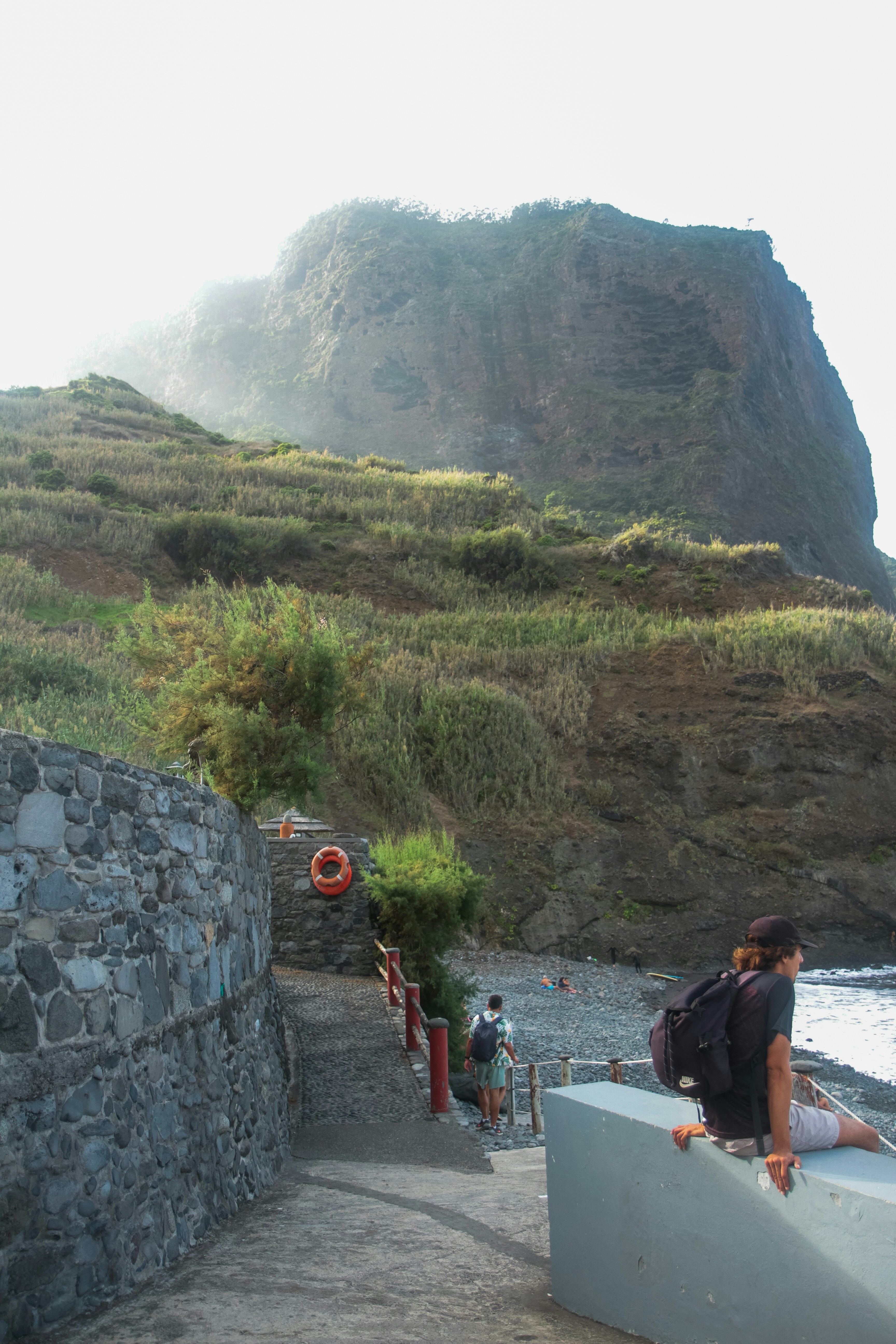 Cliffside Pause: Hikers Along a Terraced Coastal Path