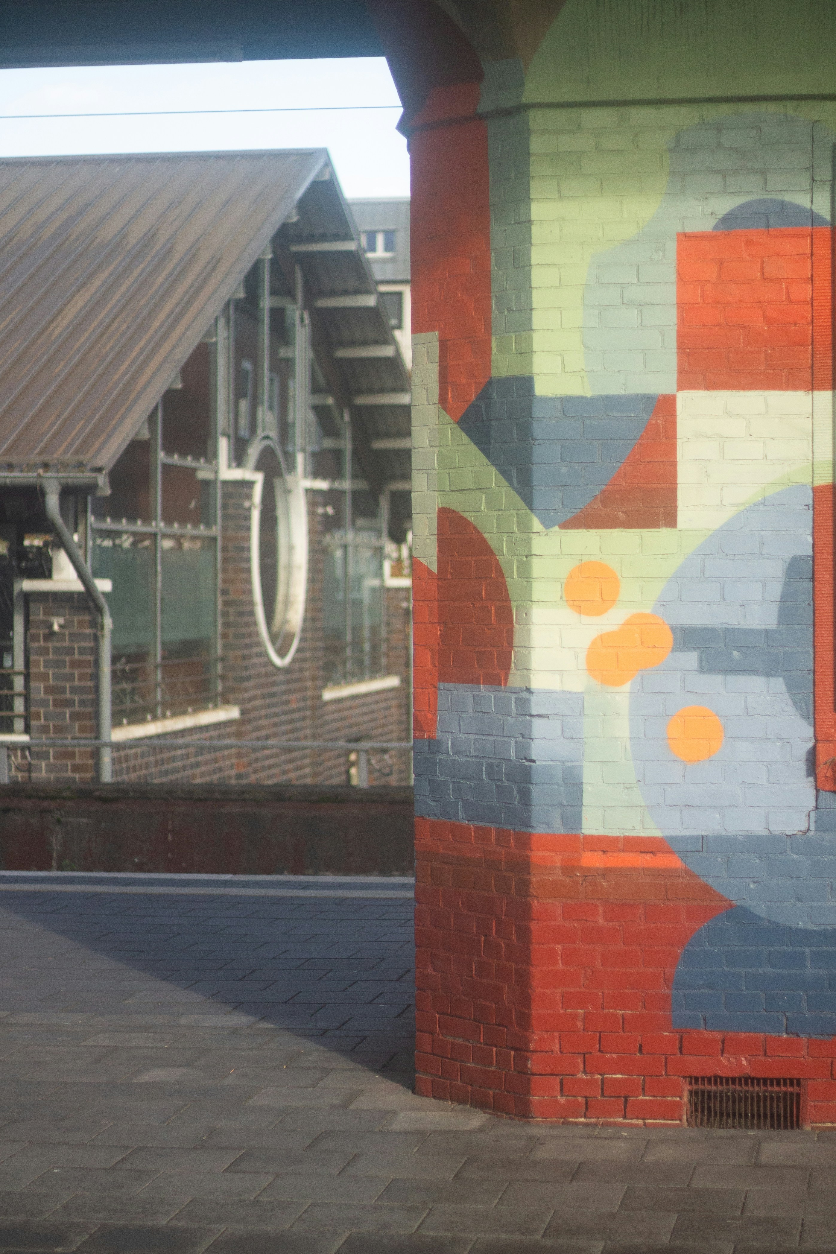 Pillar of Color: A Geometric Mural Reimagines an Urban Brick Corner