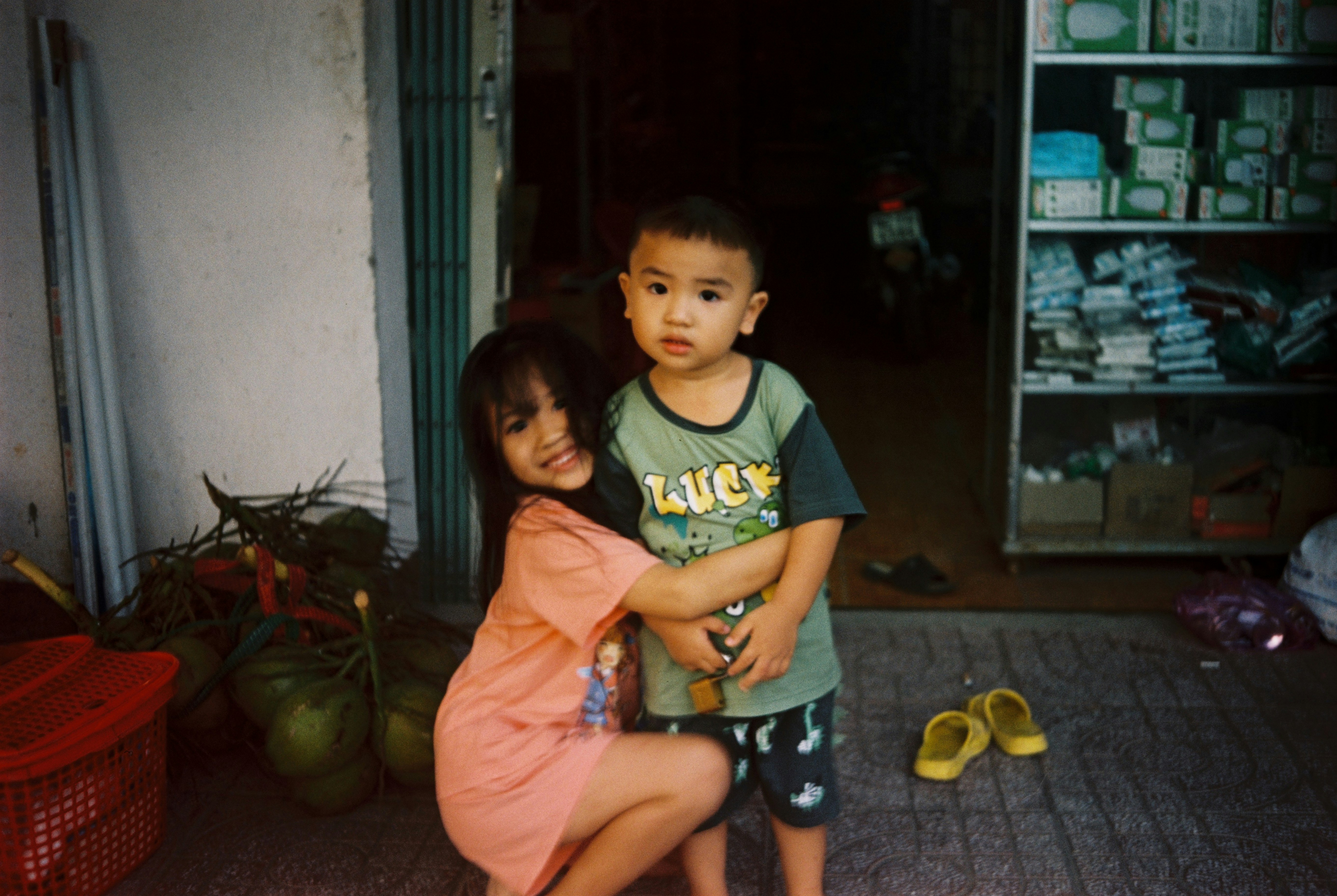 Hug in the Threshold: A Quiet Moment at the Market Front
