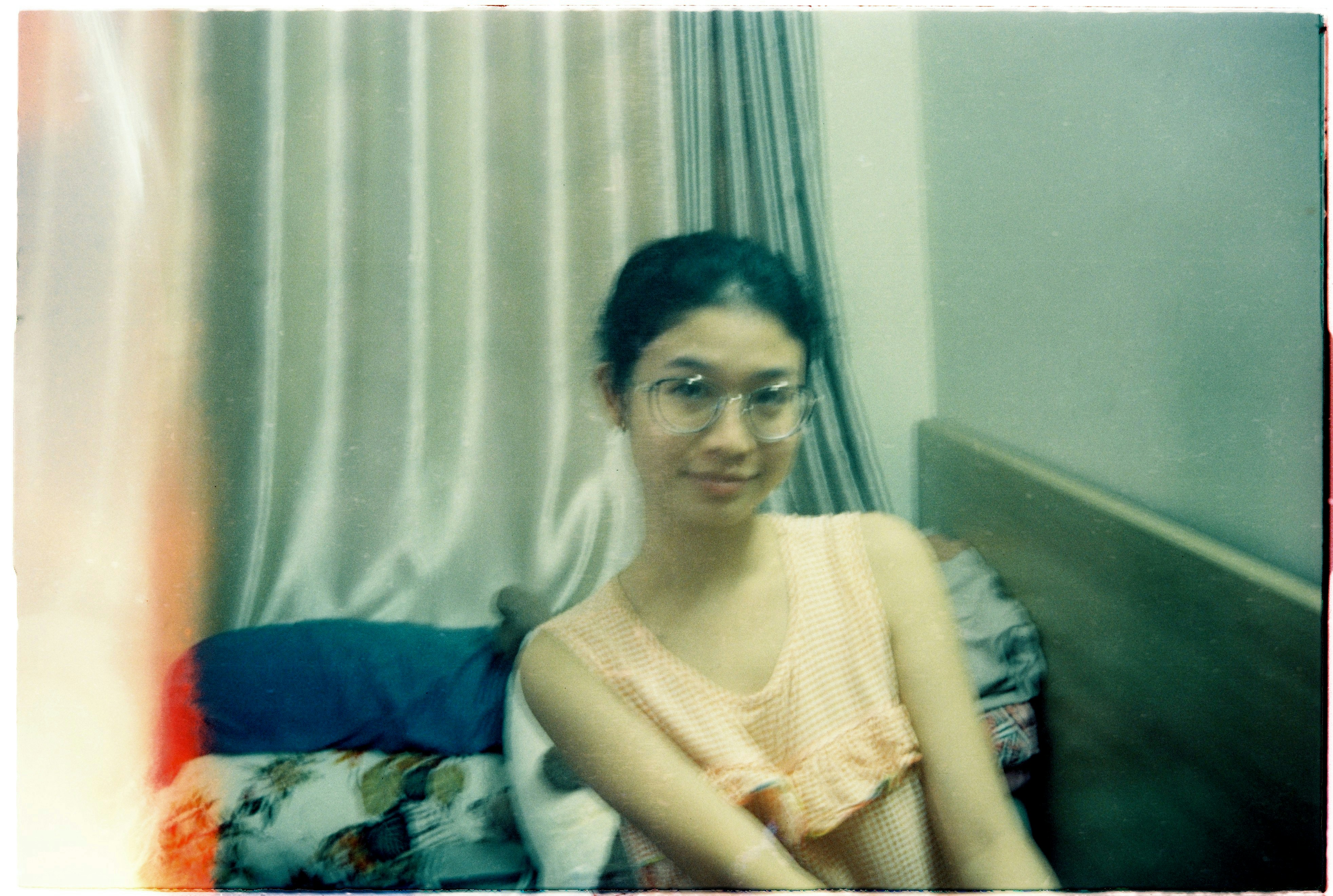 Soft-focus Portrait in a Sunlit Bedroom with Vintage Film Tone