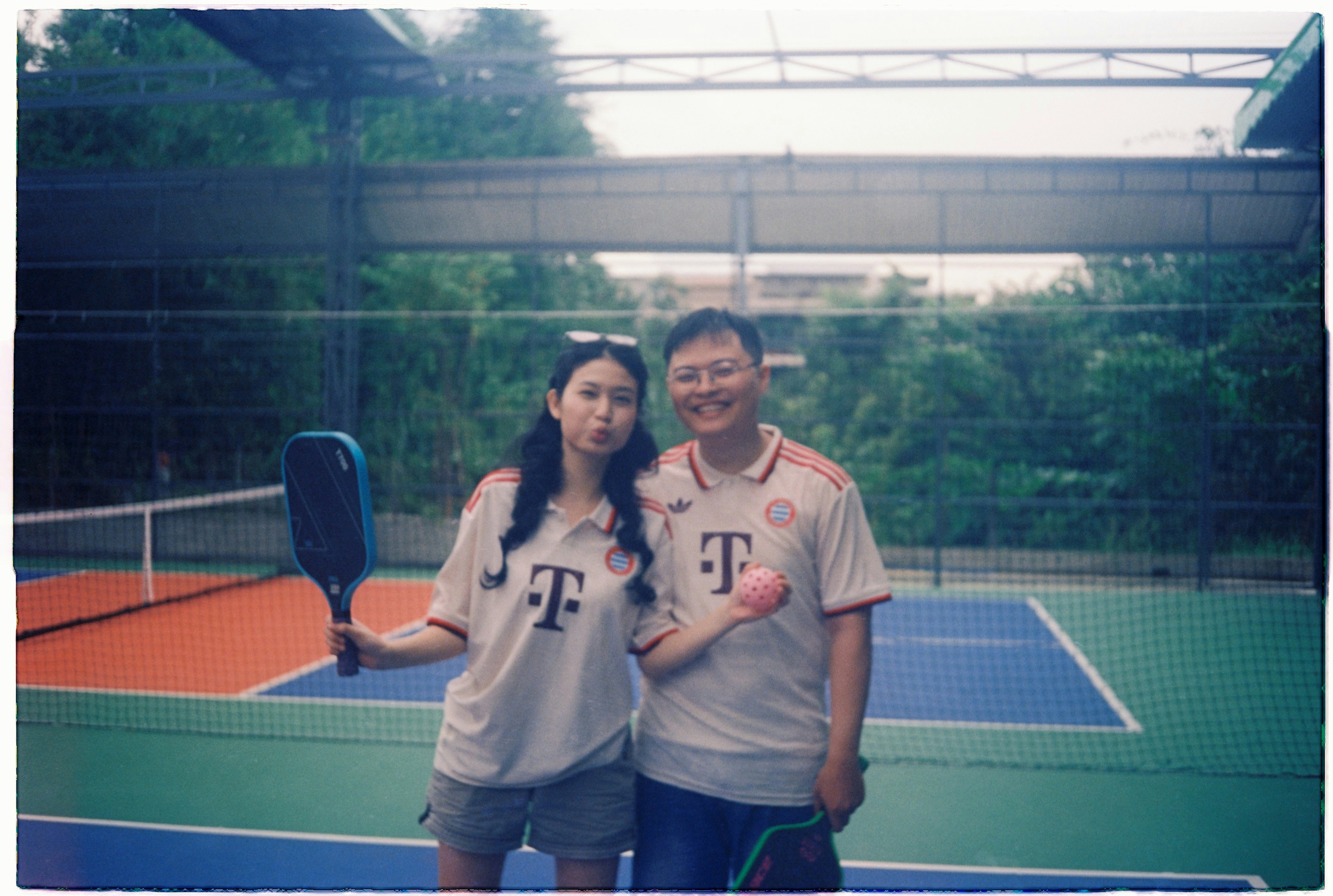 Double Portrait on a Neon Court: Friends in Matching Jerseys