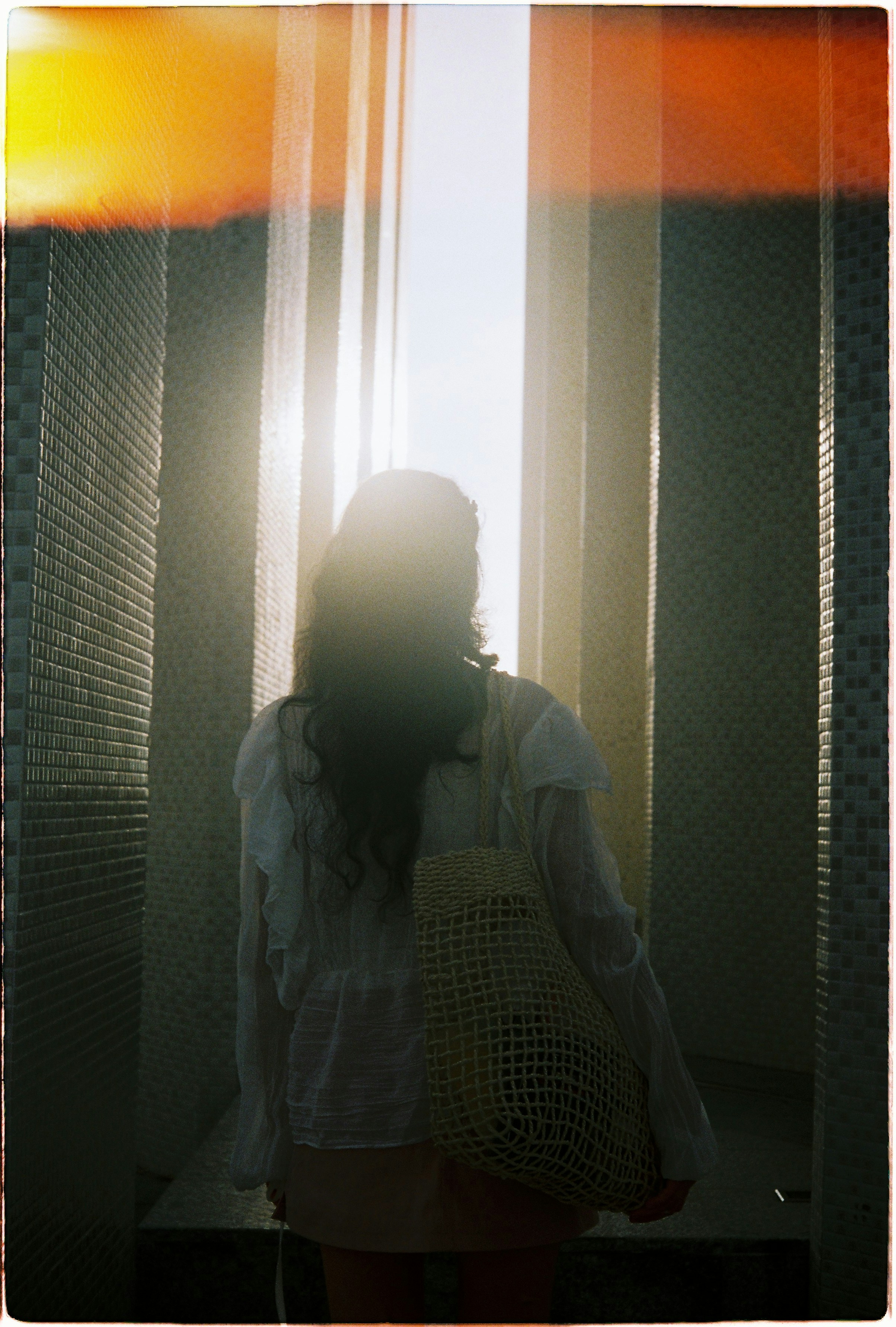 Sunlit Silhouette in a Pillared Corridor