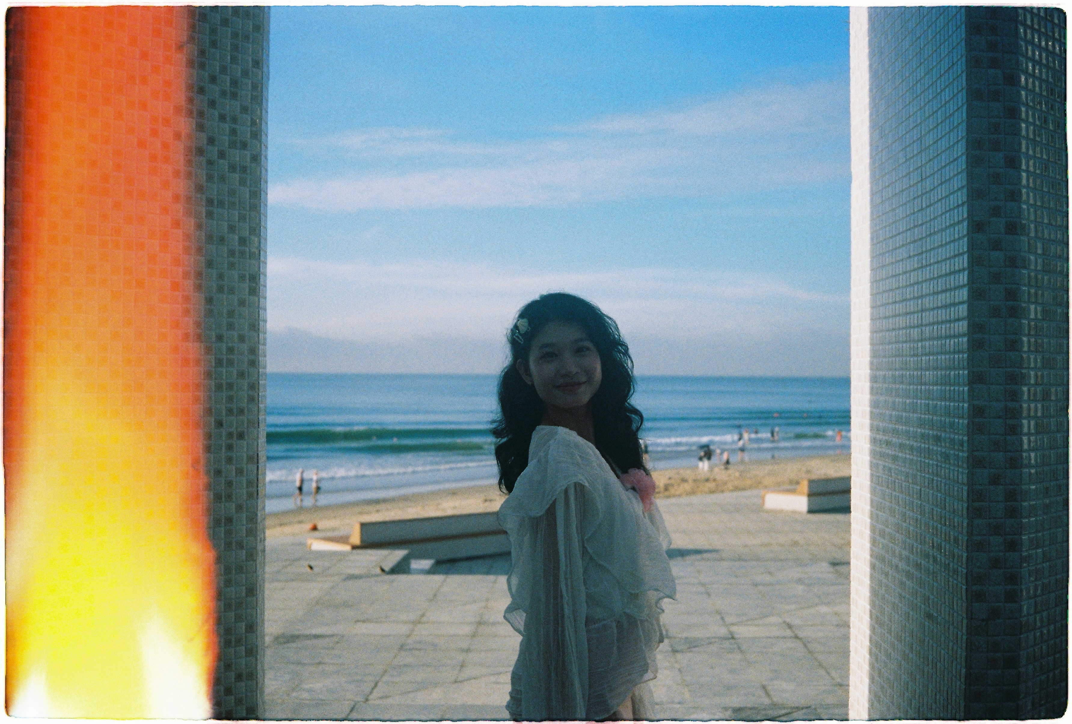 Doorway to the Sea: A Portrait Framed by Coastal Columns