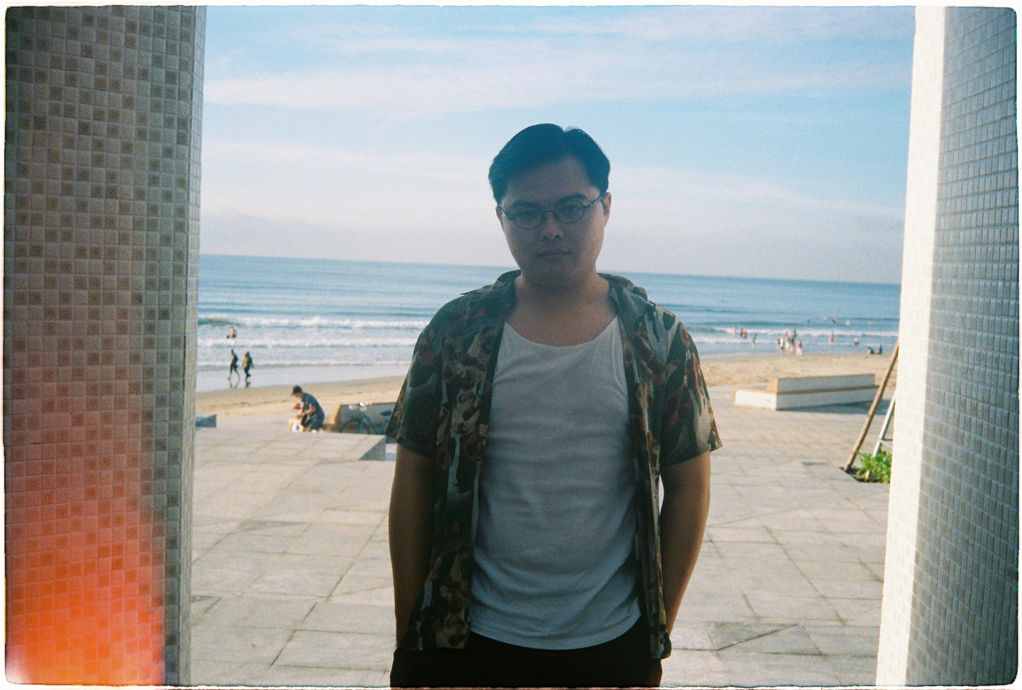 Seaside Arch Portrait: Quiet Confidence Framed by Beachfront Columns