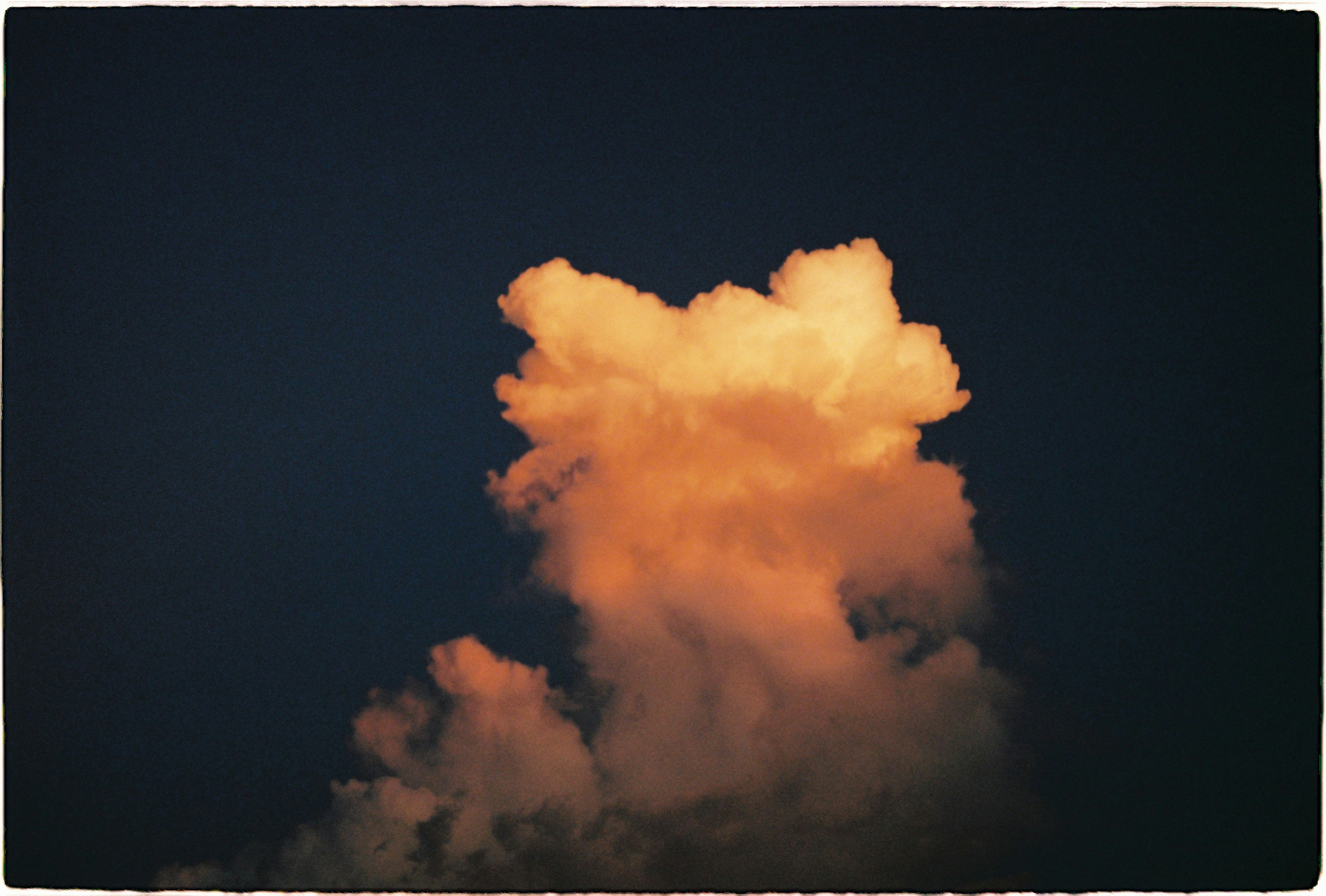 Amber Cumulus Glowing Against a Velvet Night Sky