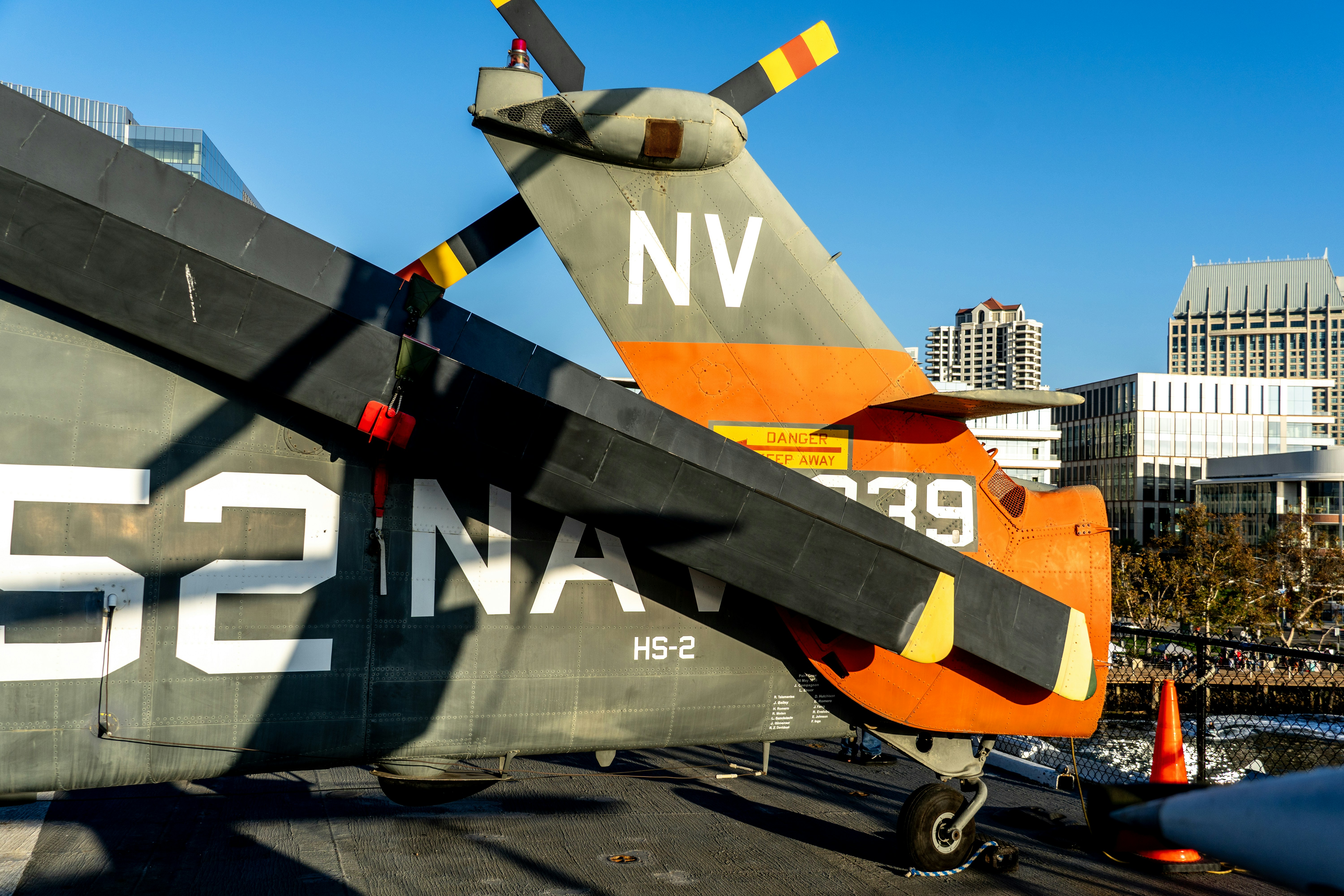 NV Tail at the Harbor: A sunlit helicopter against a city skyline