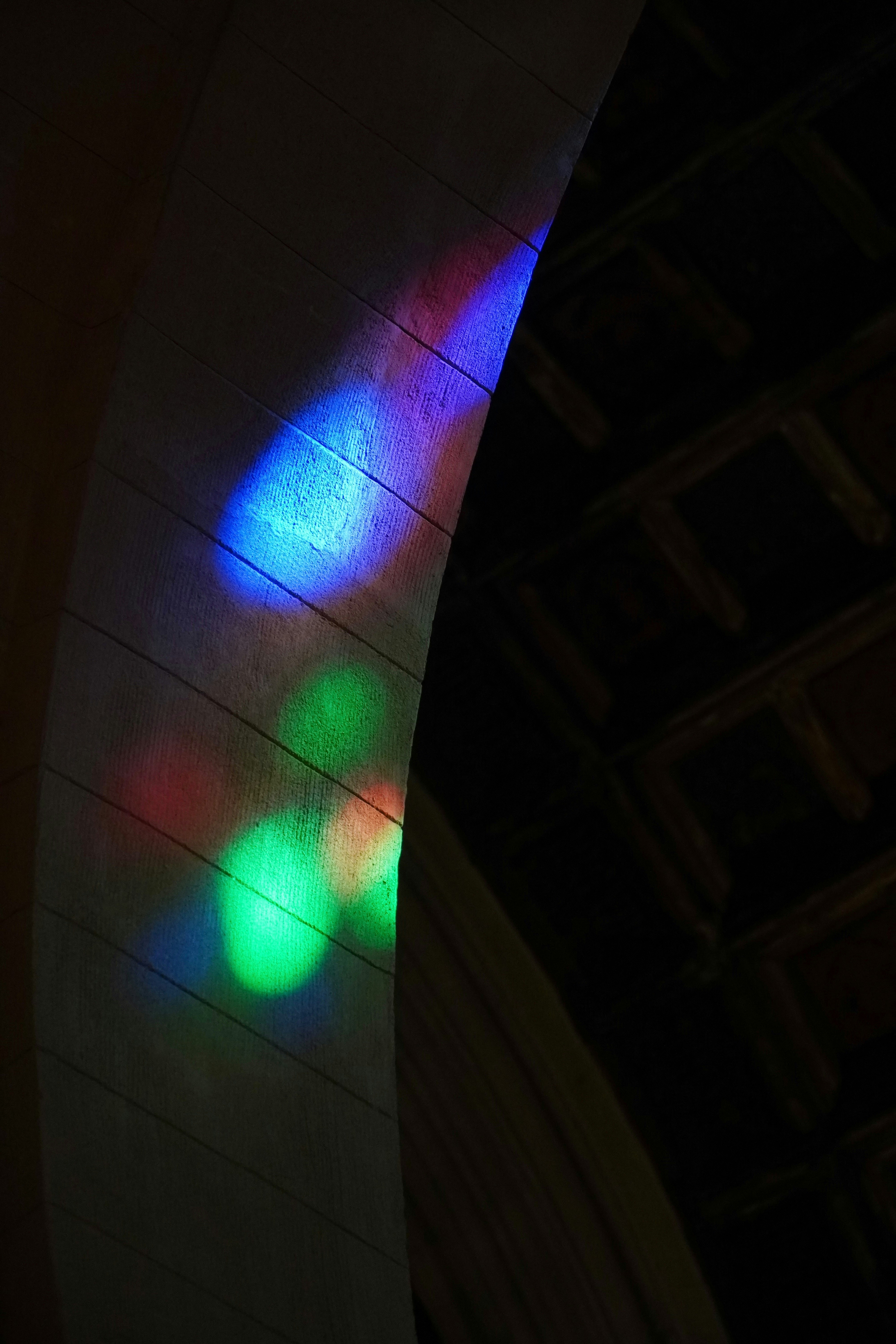 Rainbow Orbs Tracing a Curve in a Dark Interior