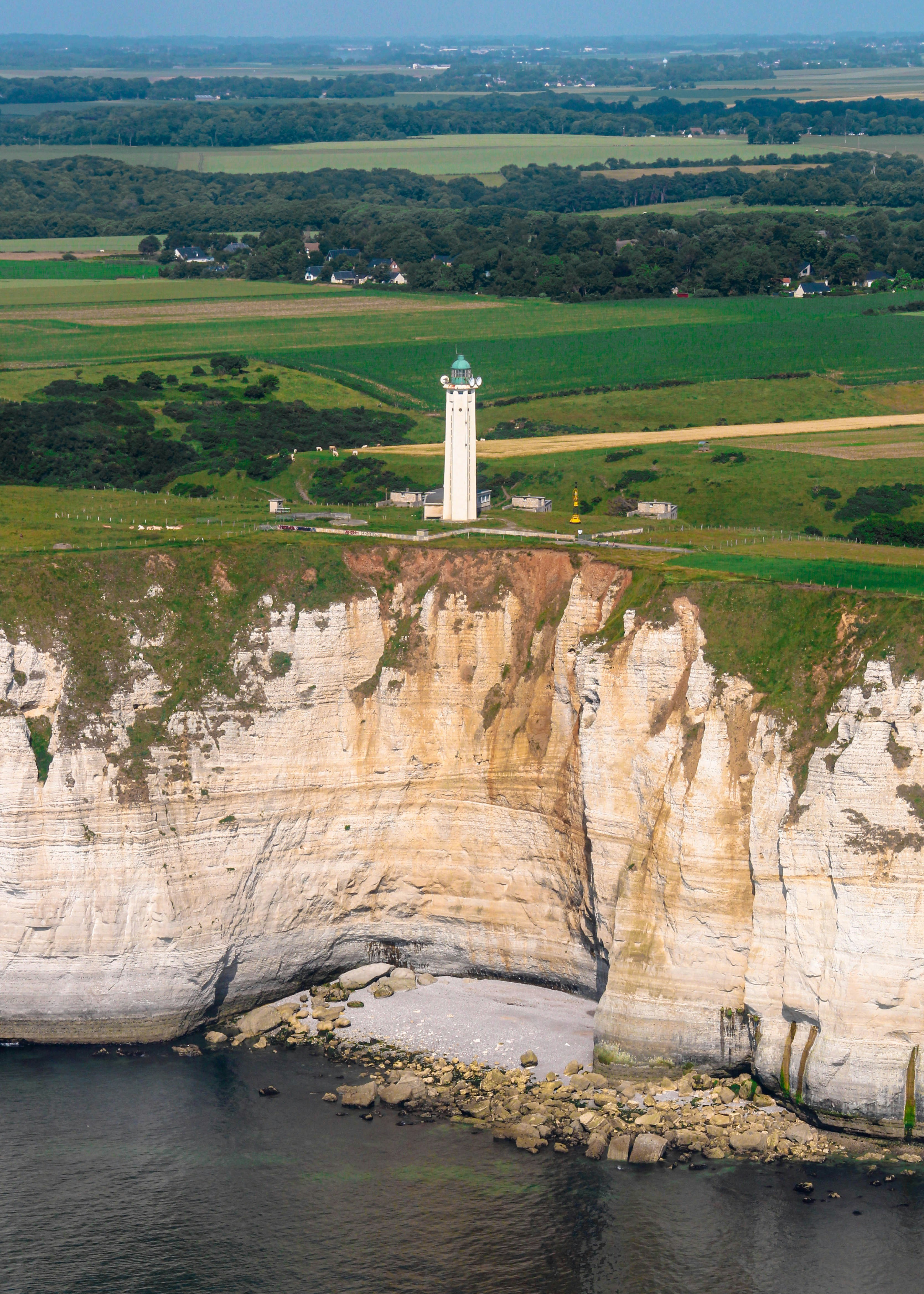 Beacon Above the Chalk Cliffs: Lighthouse on Verdant Plateaus