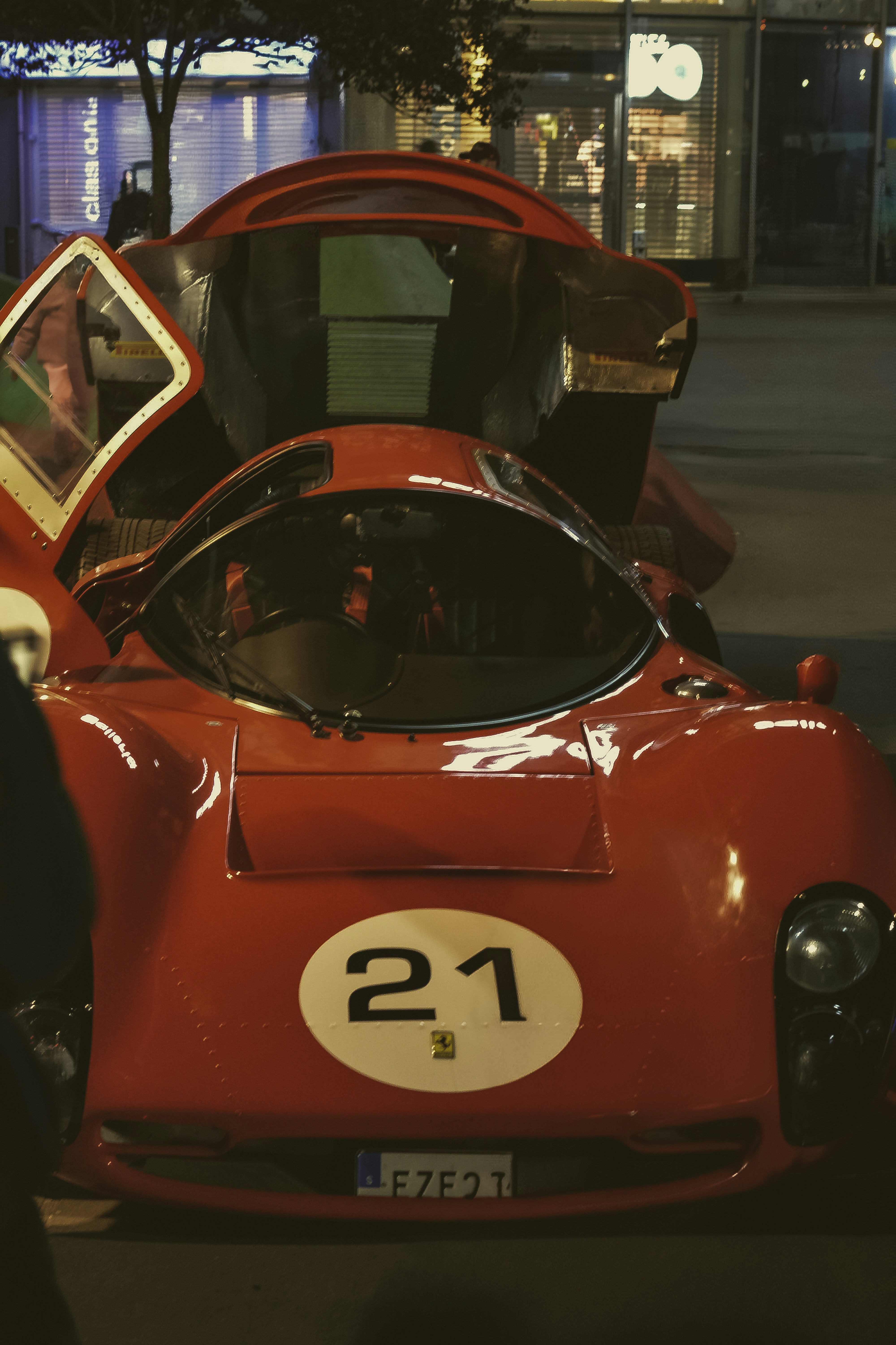 Scarlet classic race car #21 under urban night glow