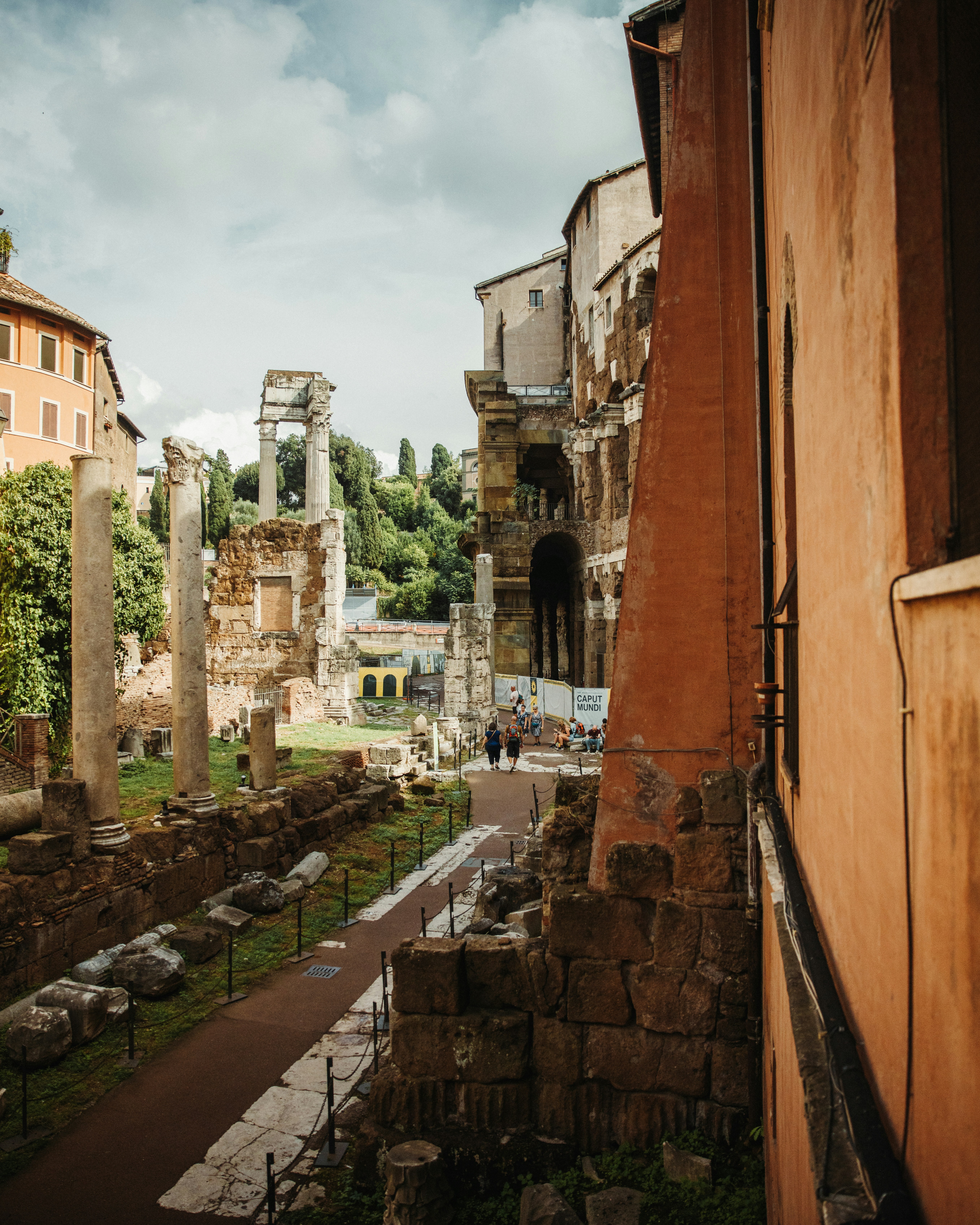 Sunlit Colonnade Through Roman Ruins: A Walk Along Timeworn Stone