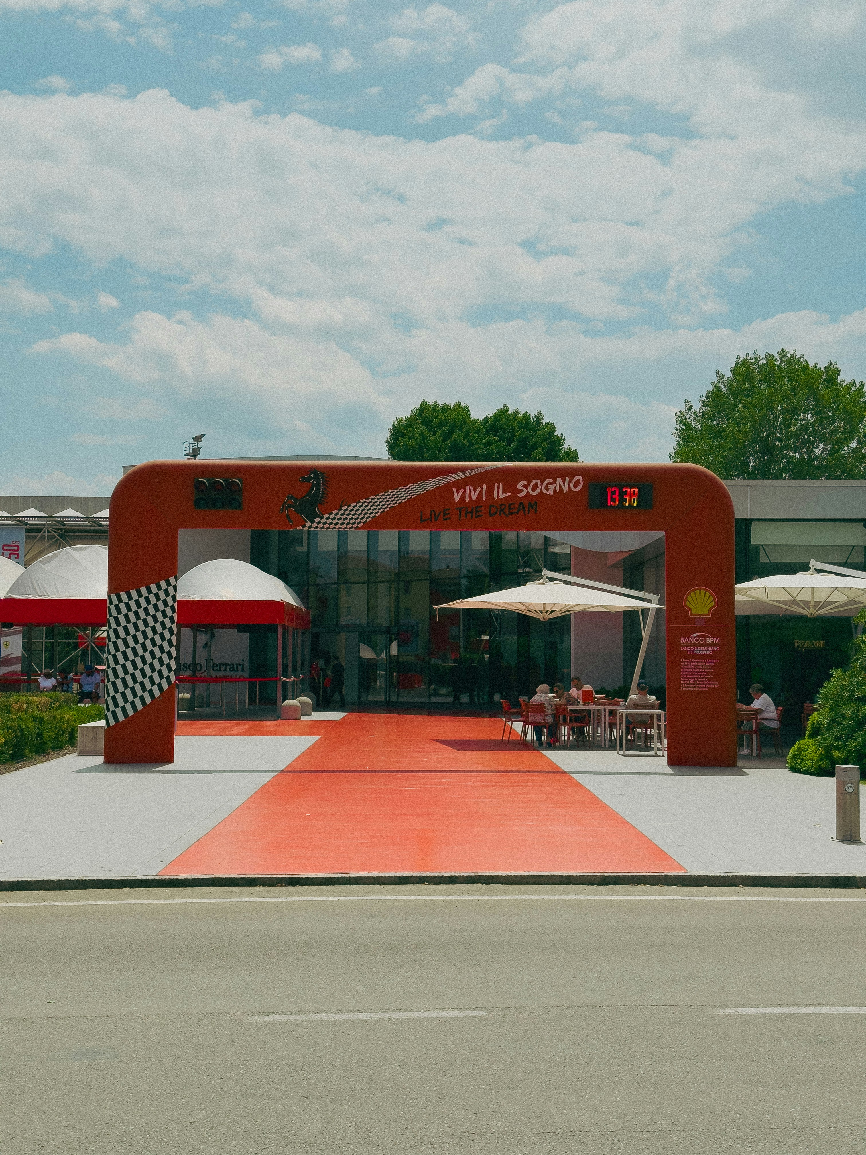 Entrance of Museo Ferrari in Maranello, Italy, featuring the iconic red archway and “Vivi il Sogno – Live the Dream” sign. The museum celebrates Ferrari’s rich racing heritage and legendary sports car innovation.