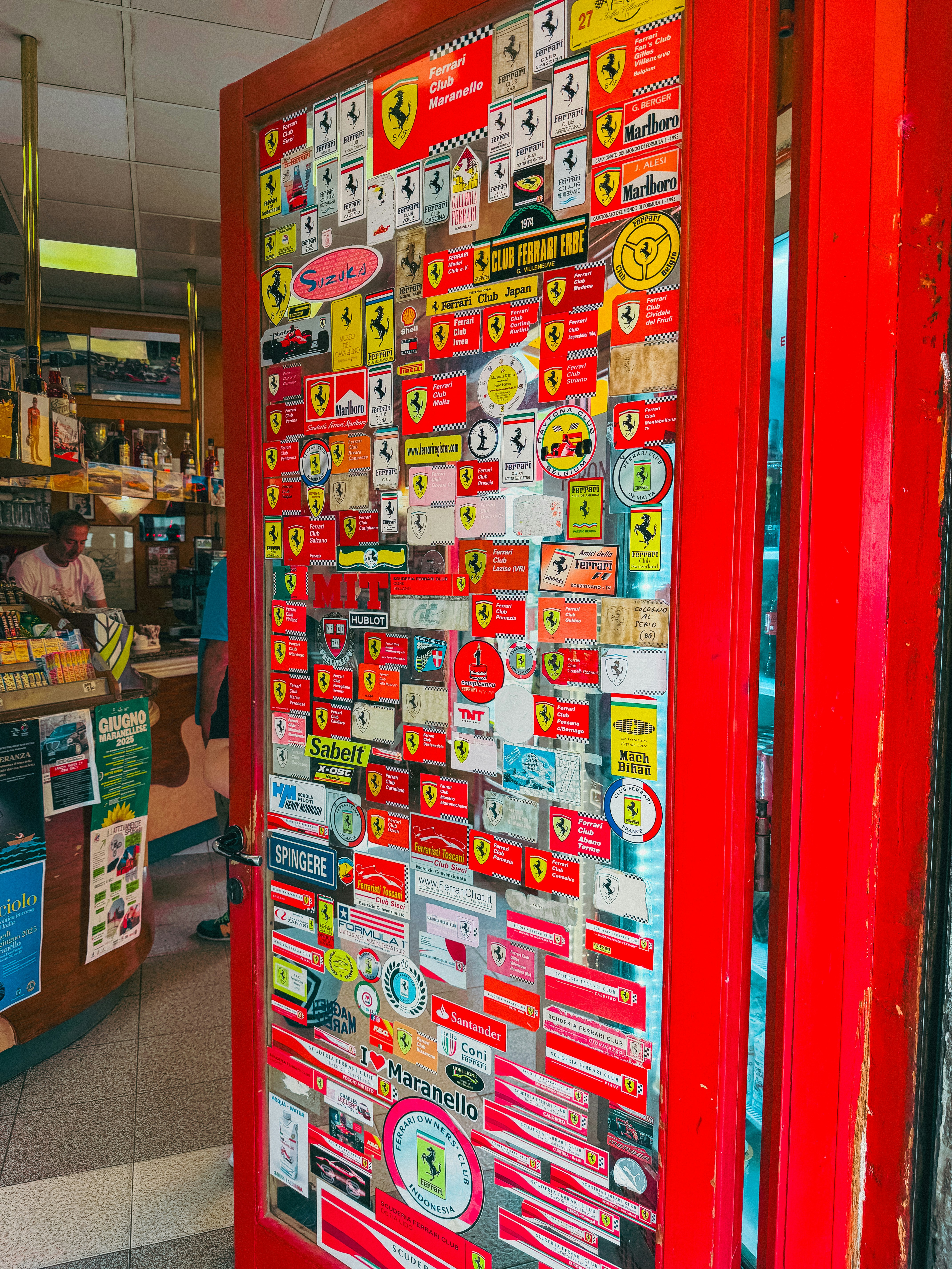 Crimson Door Mosaic: A dense collage of brand logos on a shopfront panel