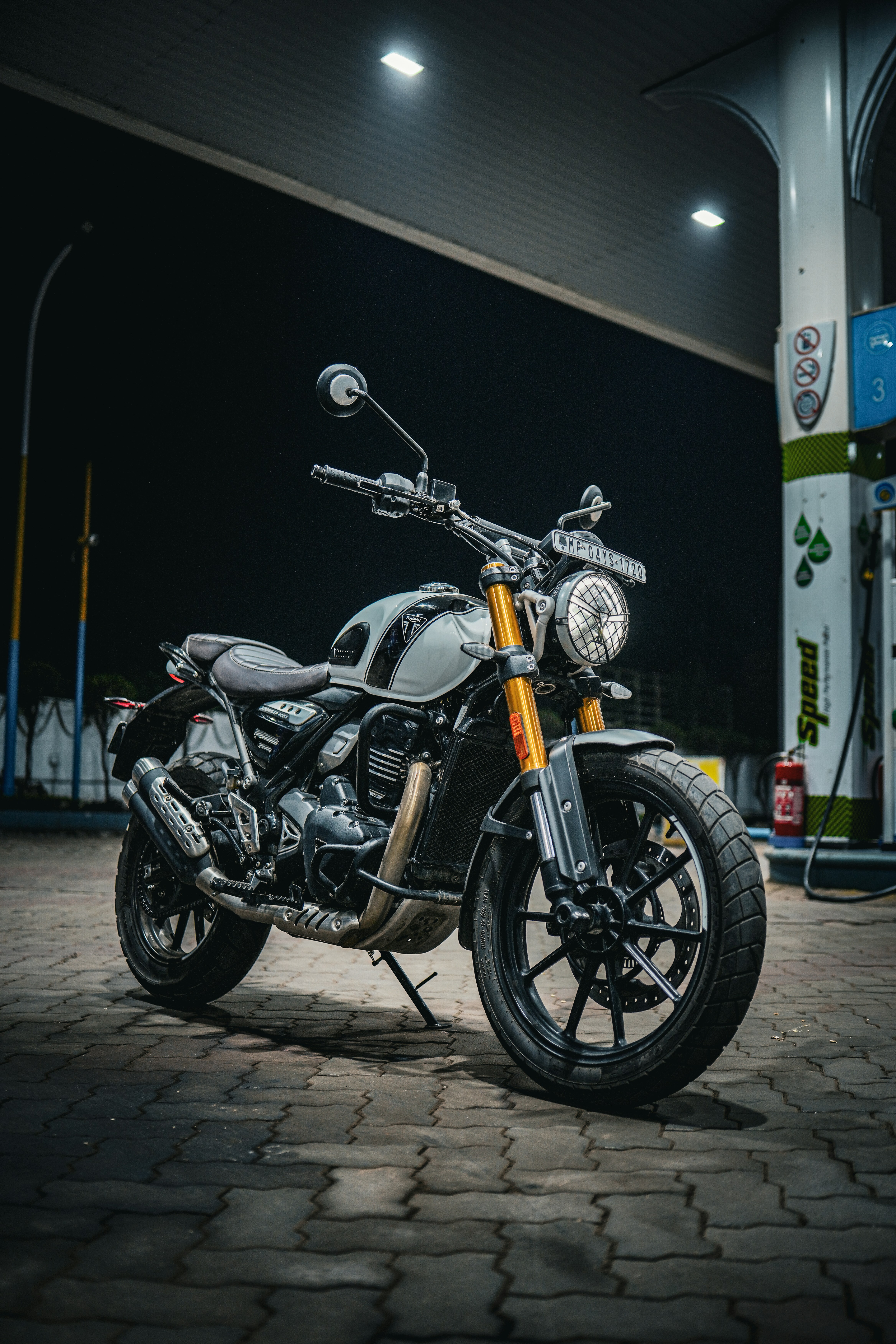 Midnight Steel: A Neo Café Racer Stands Bold Under Neon Pump Lights