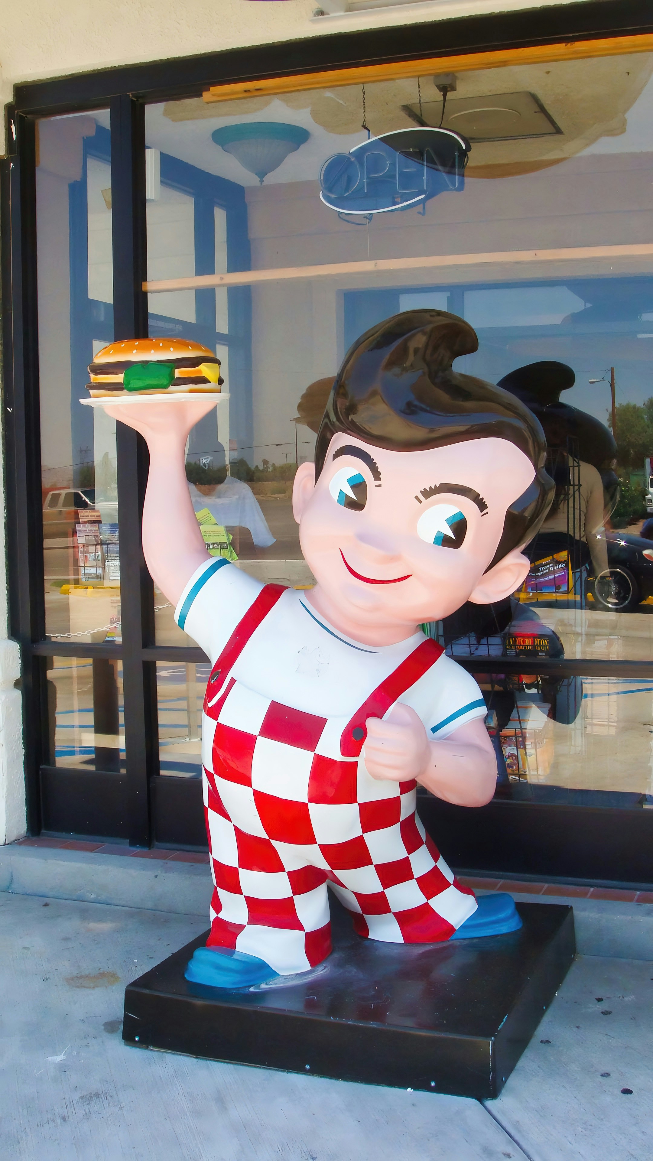 Bob's big boy statue holding a hamburger outside restaurant