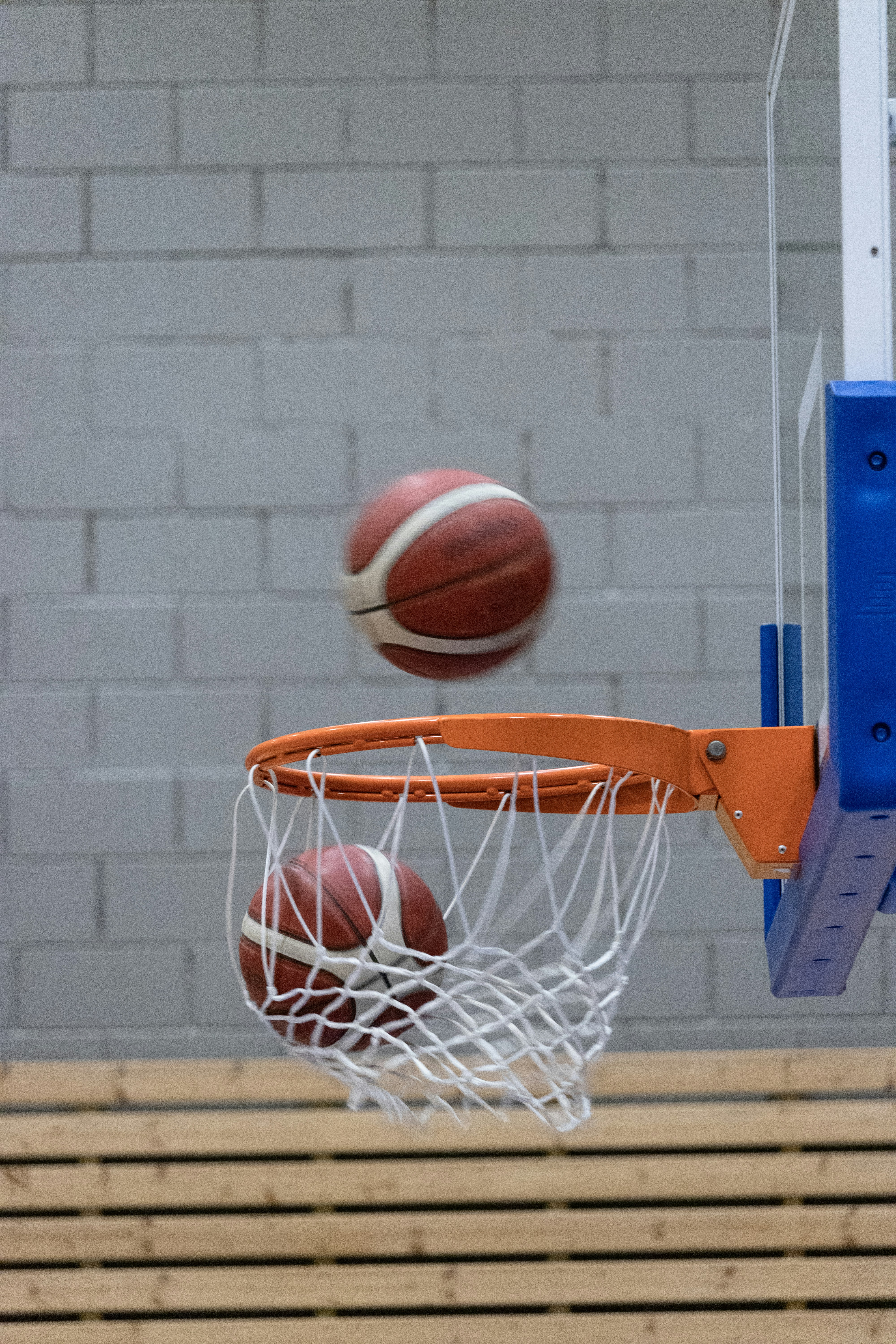 Basketball going through a net with another ball in it