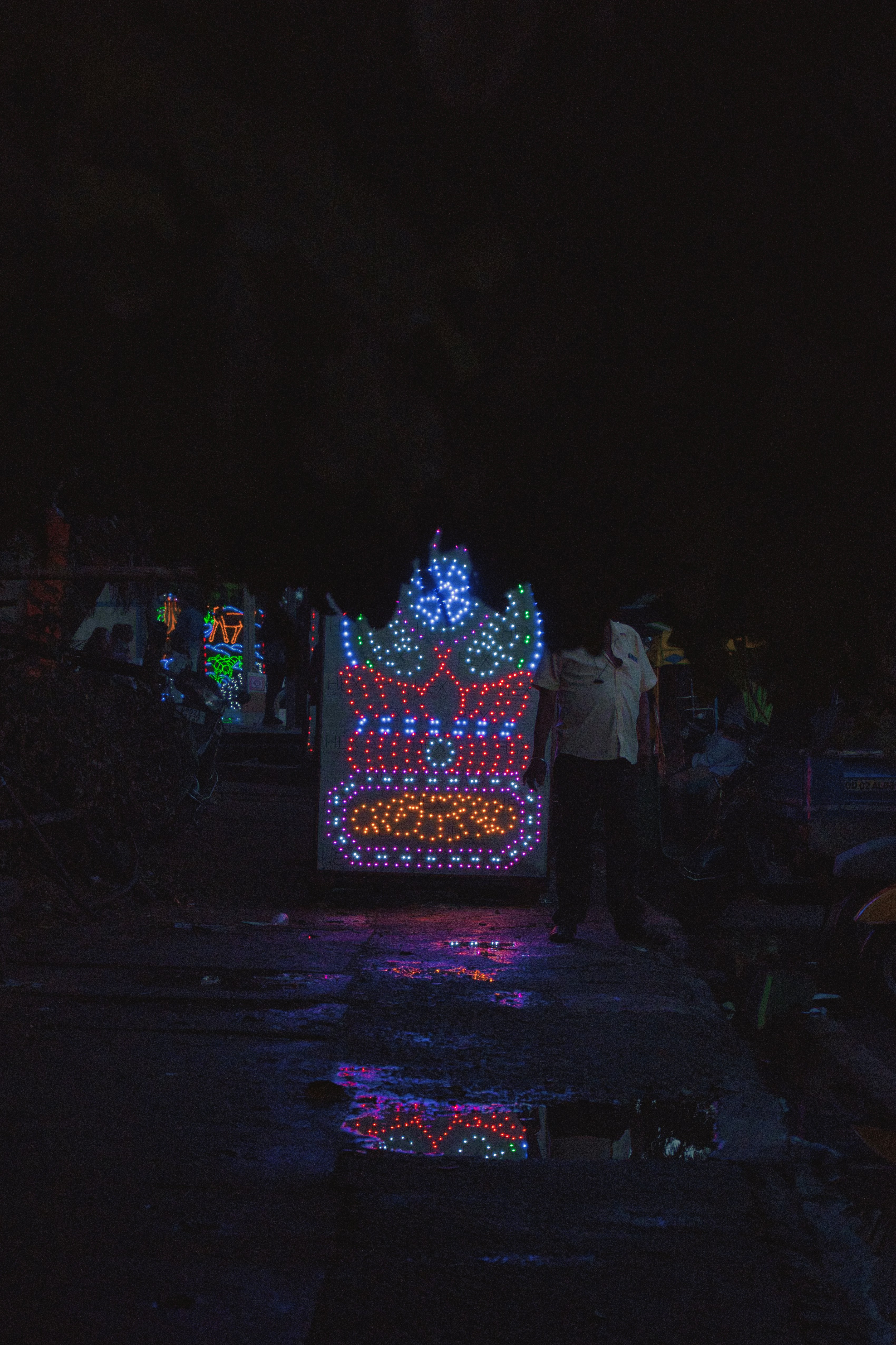 Neon Lotus Bloom Illuminates a Quiet Night Market