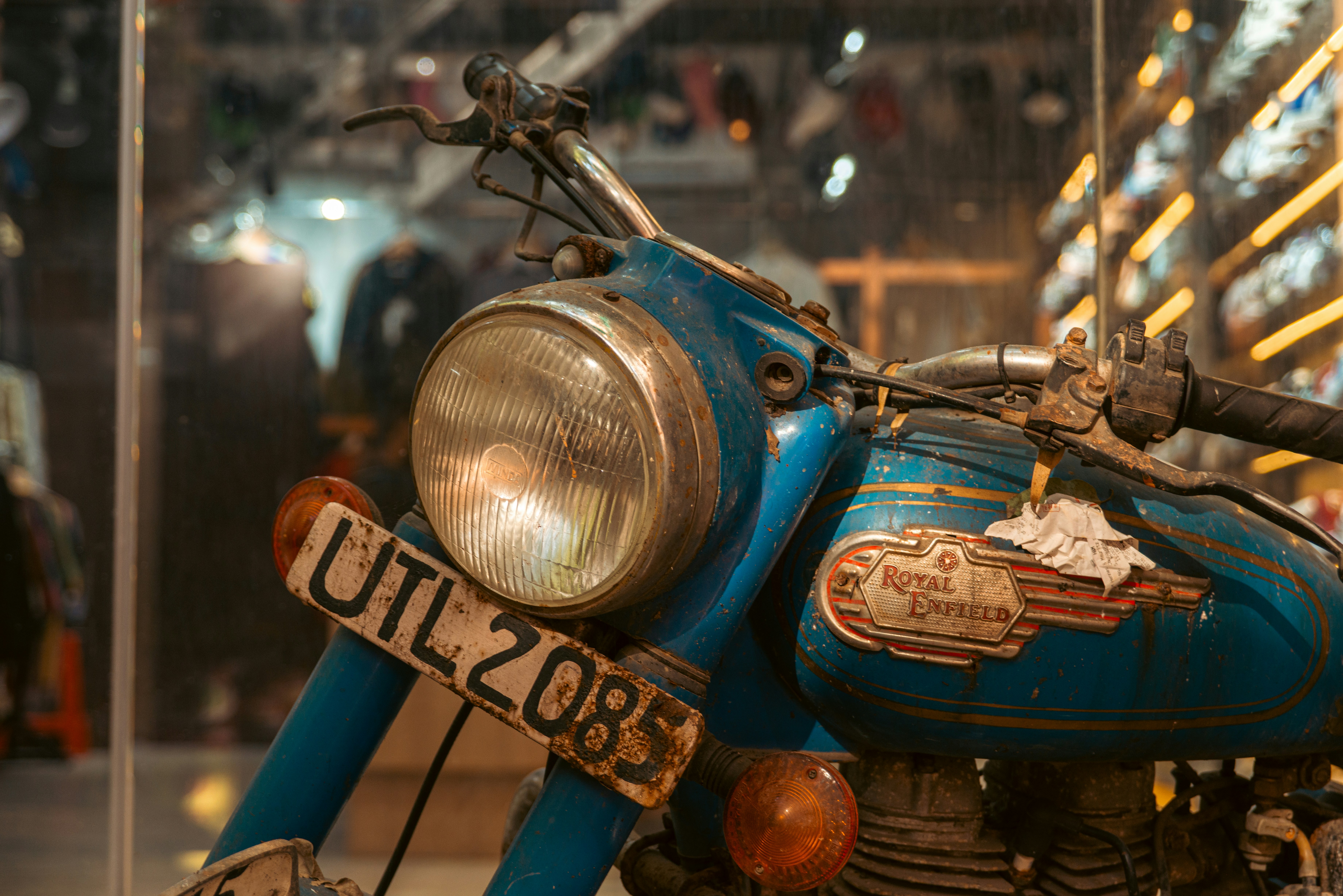 Headlight Beacon: Weathered Royal Enfield in a Museum Display