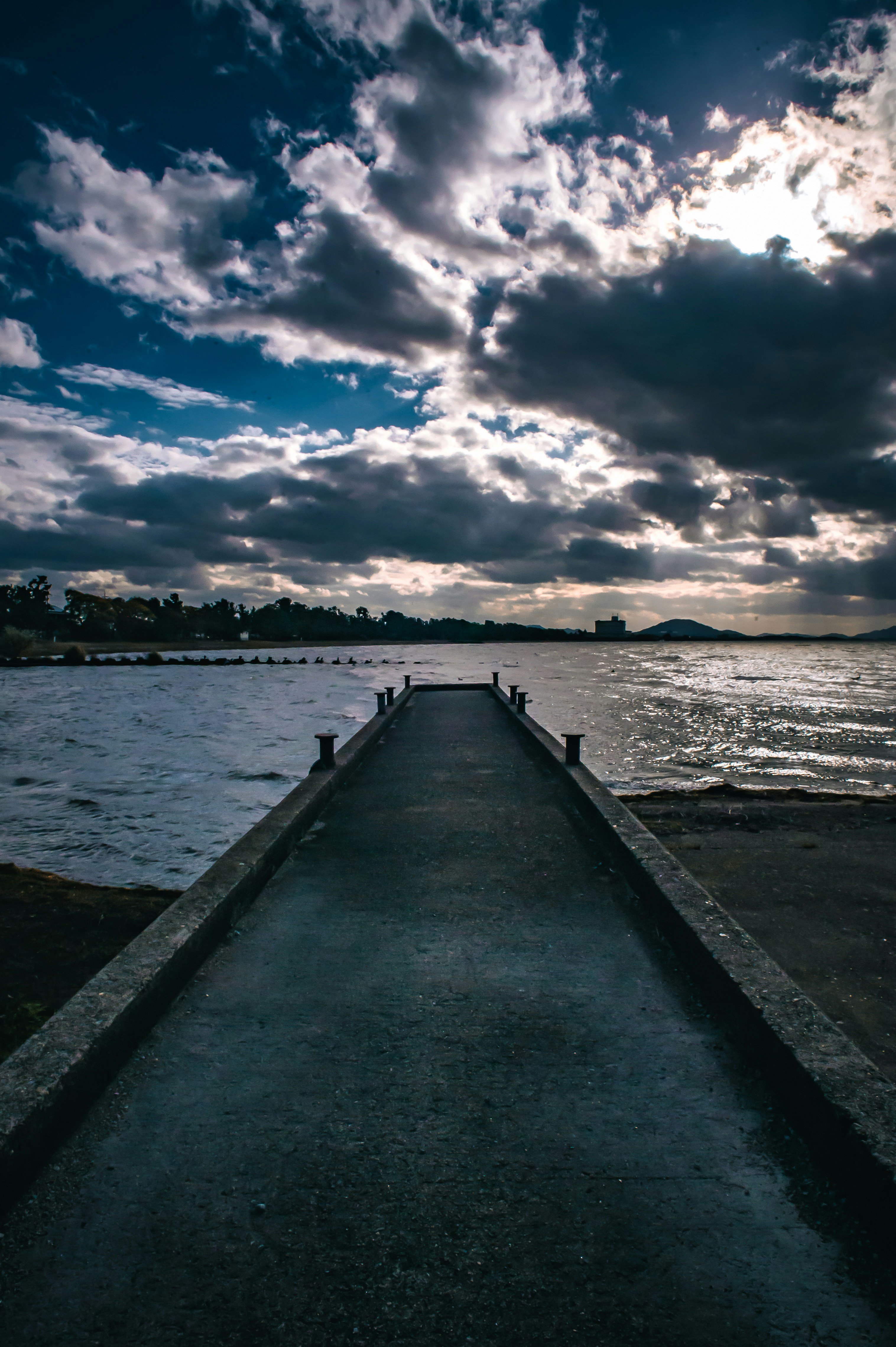 Converging Pier Toward a Cloud-Burnished Horizon