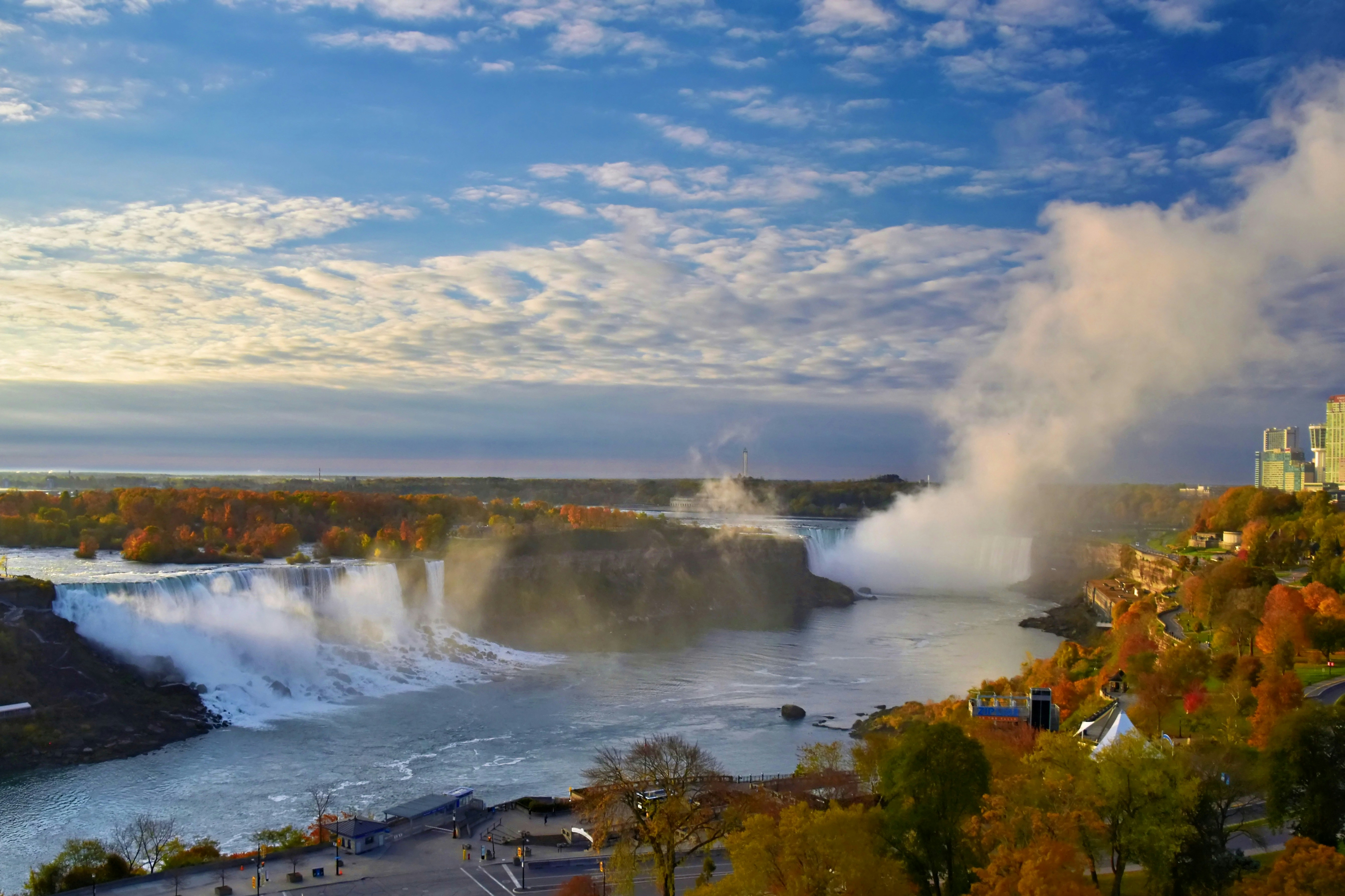 Autumn Mist Over the River Falls: Hilltop Vista of Water, Foliage, and Sky