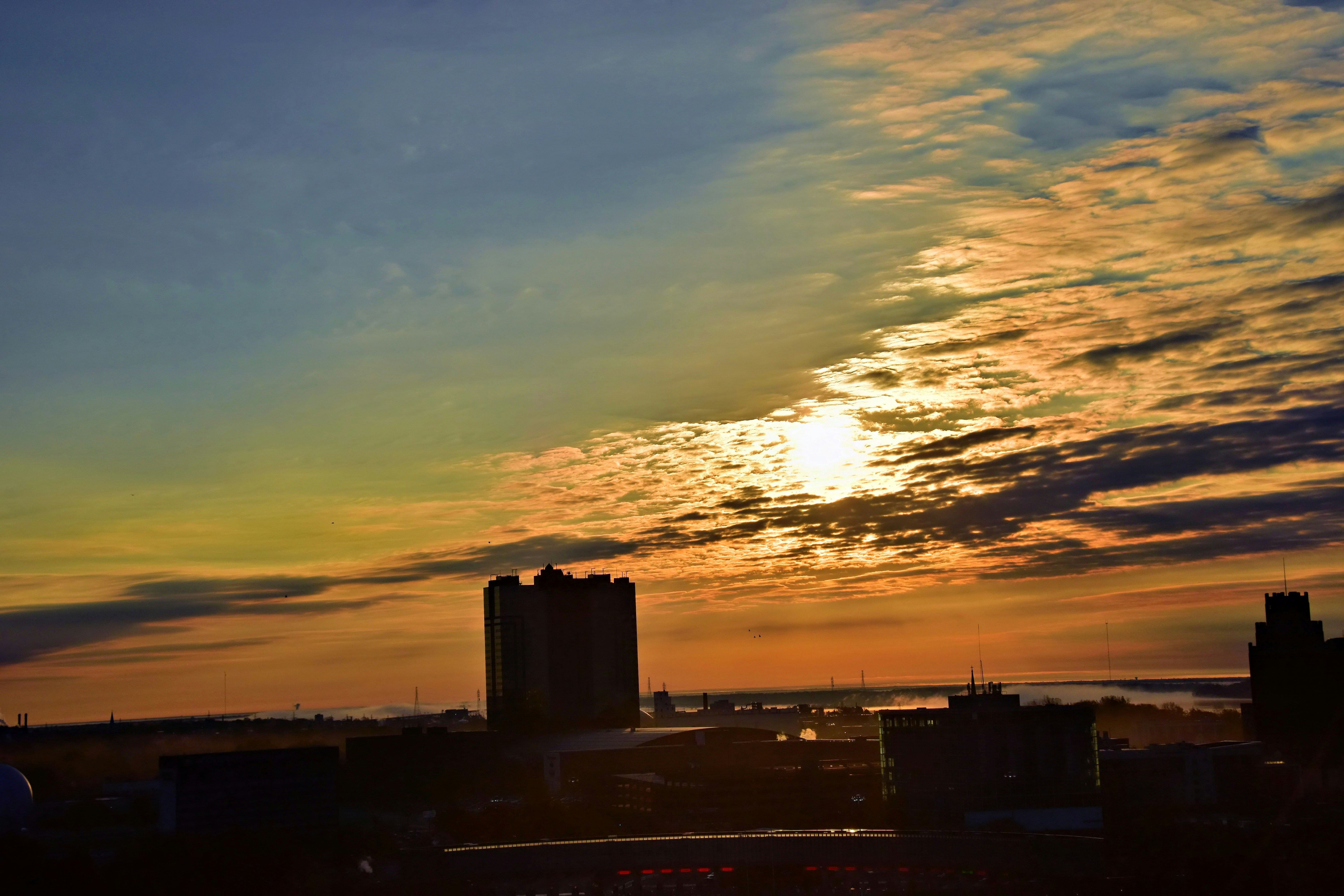 Gilded Horizon: Sunset Silhouettes Over a Quiet Waterfront