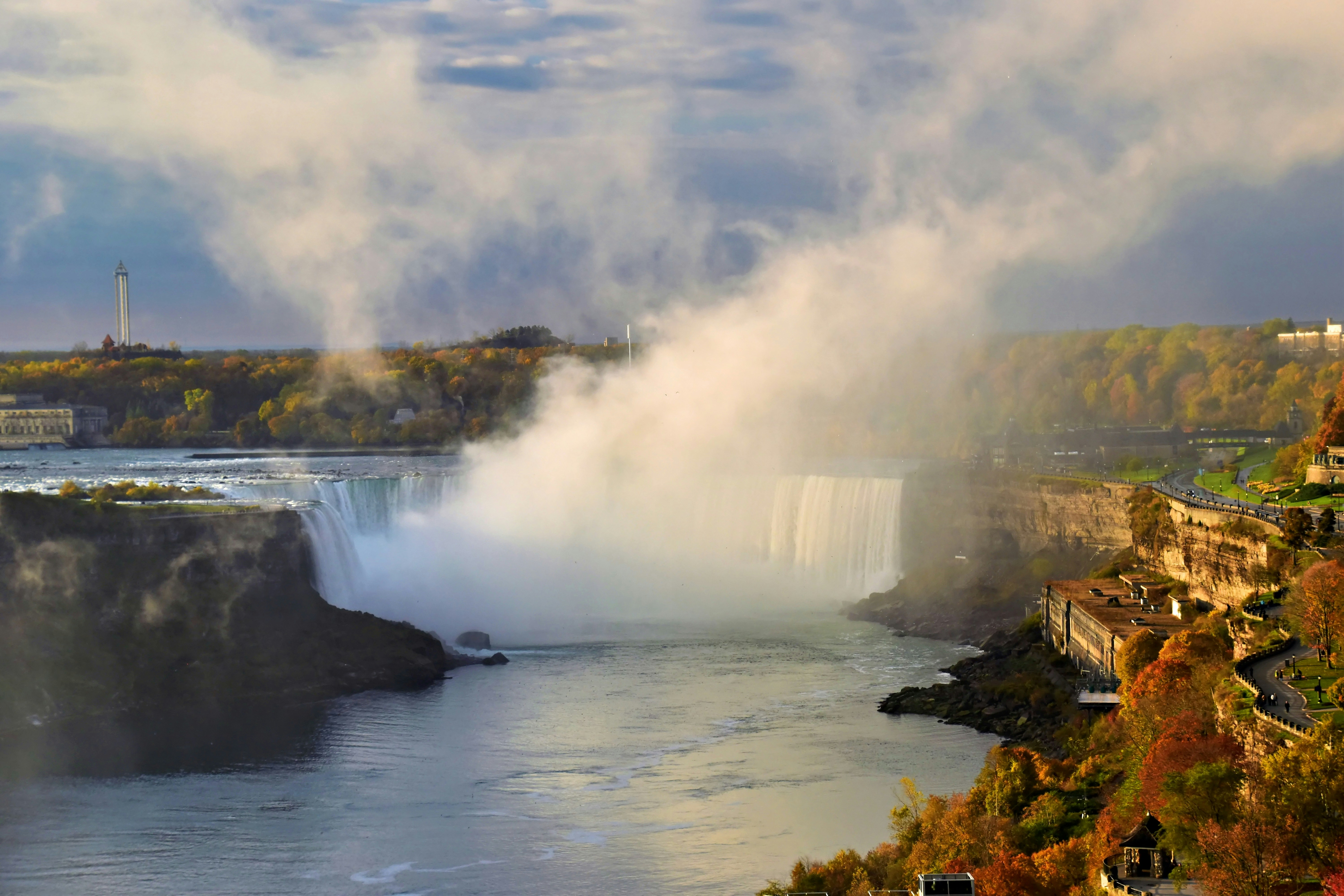 Autumn Mist Crowned by a Riverside Cascade