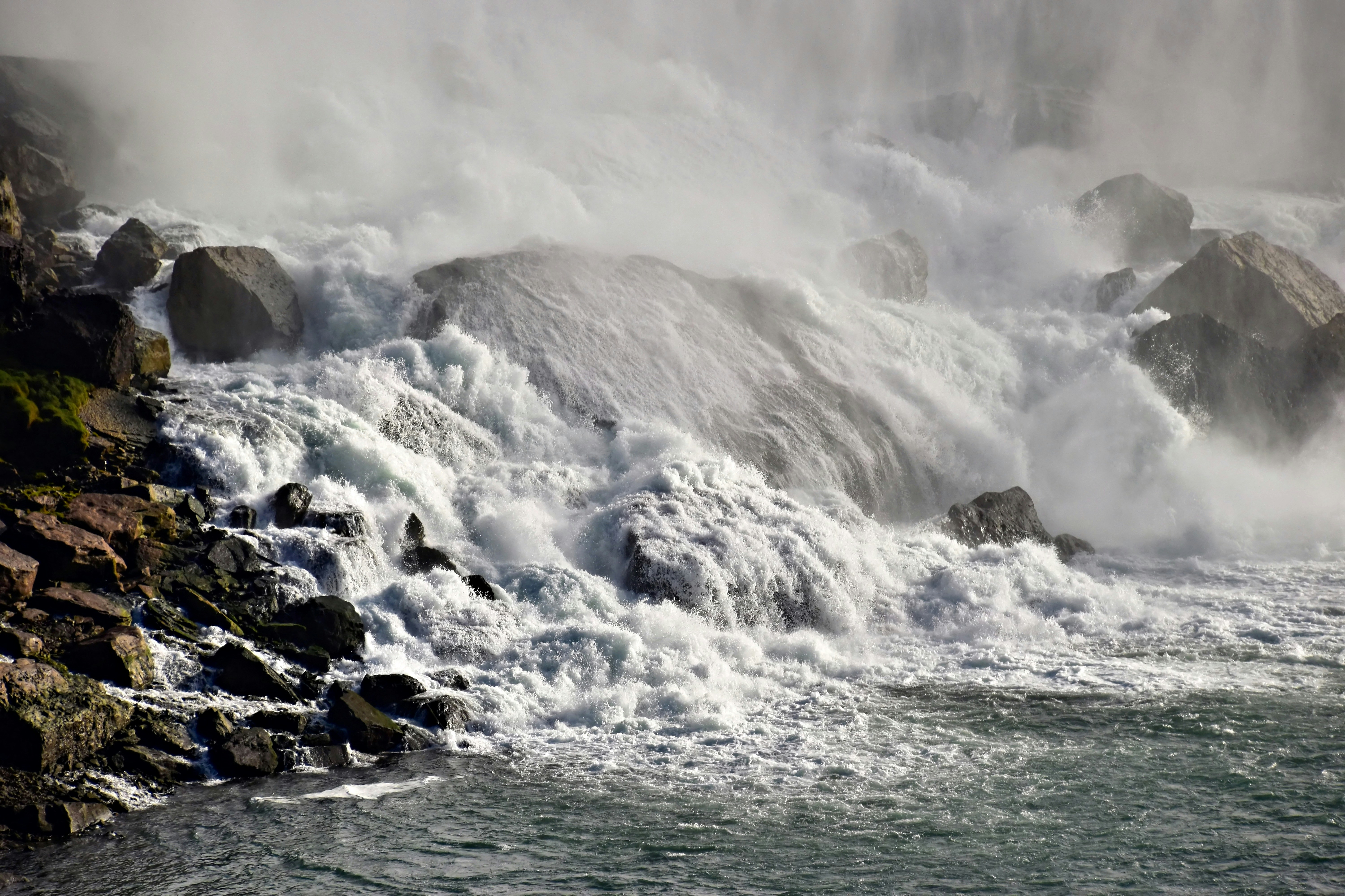 Rushing Cascade: A Wall of Whitewater Against Weathered Rocks