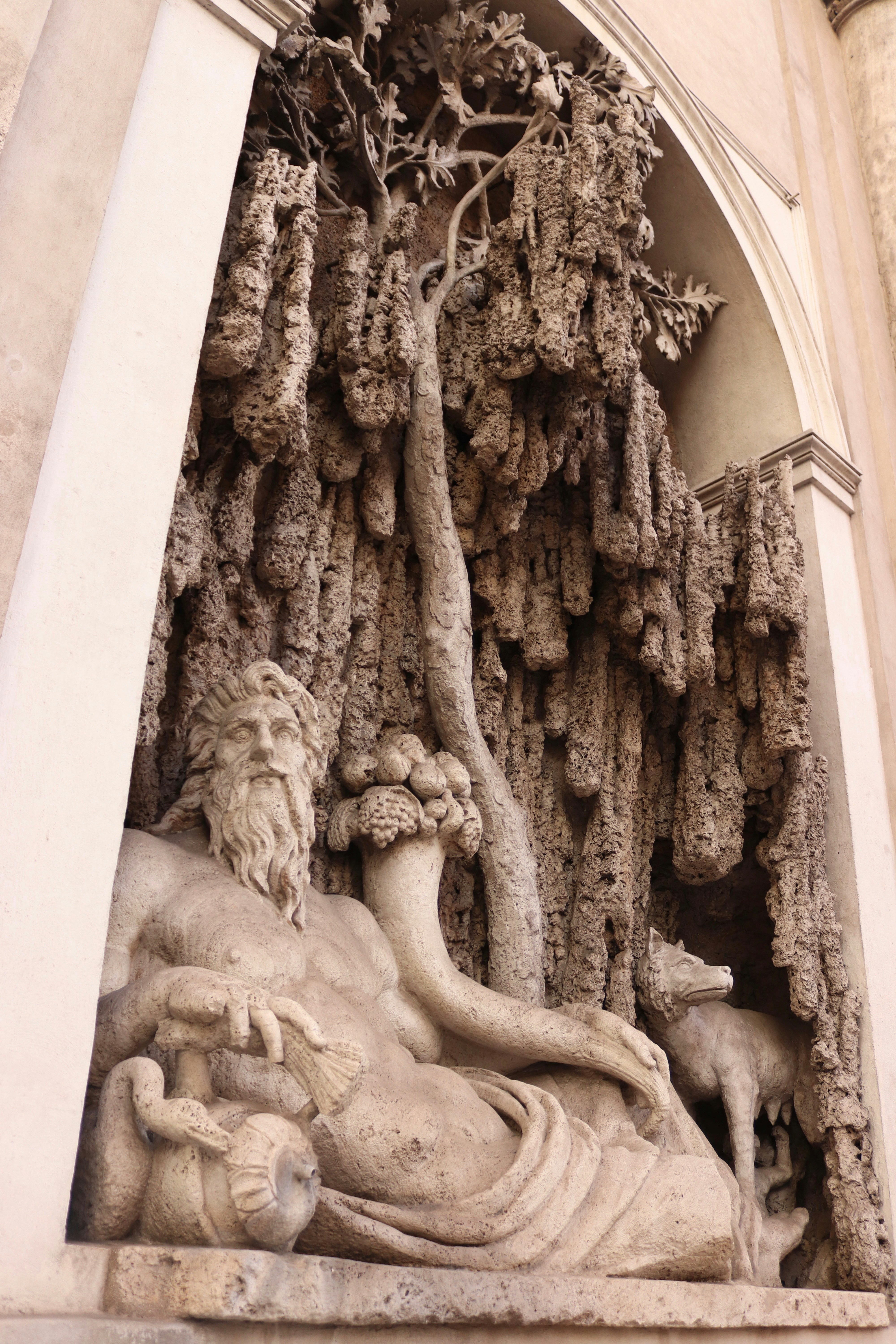 Reclining Titan Among Stone Foliage in an Arched Niche