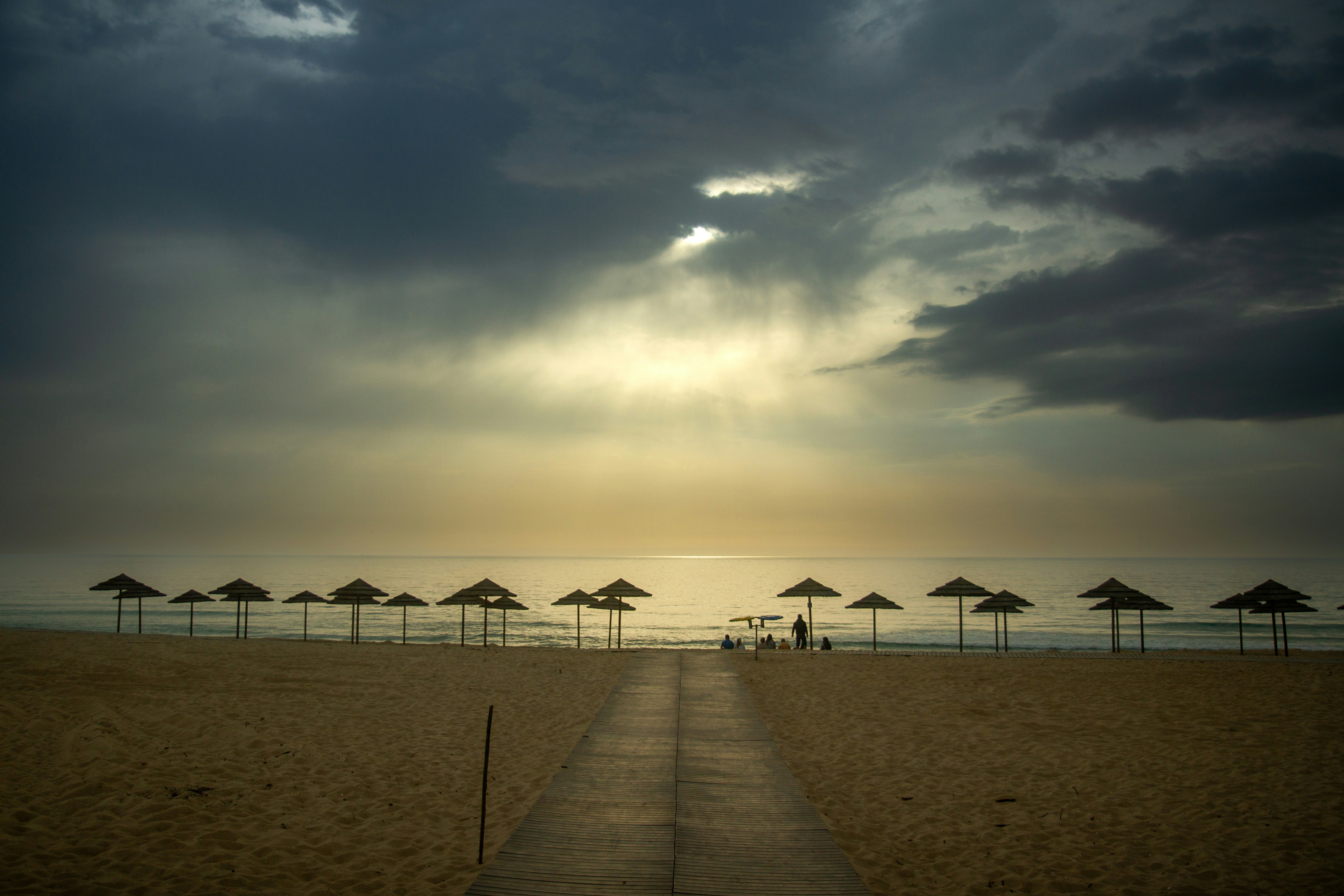 Horizon Path: A Beach Walkway under a Brooding Sky