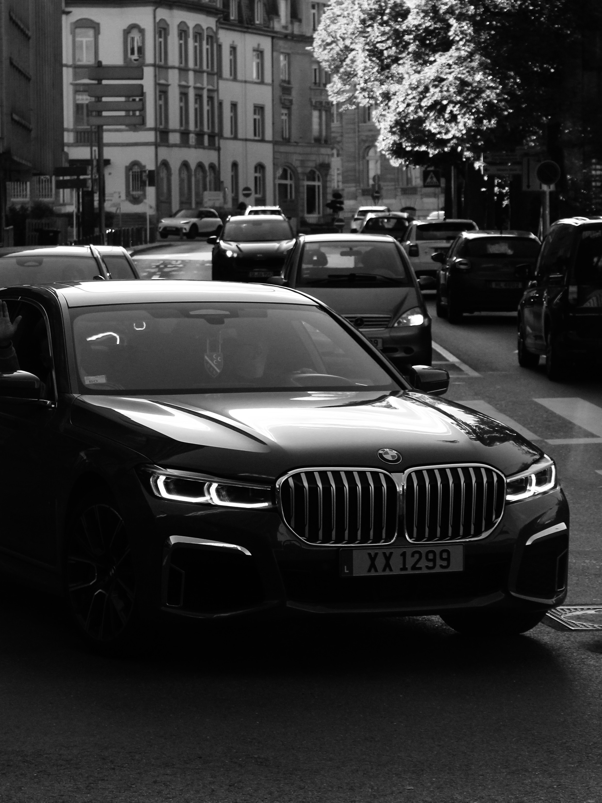 Monochrome Momentum: The BMW Front Leads a City Street