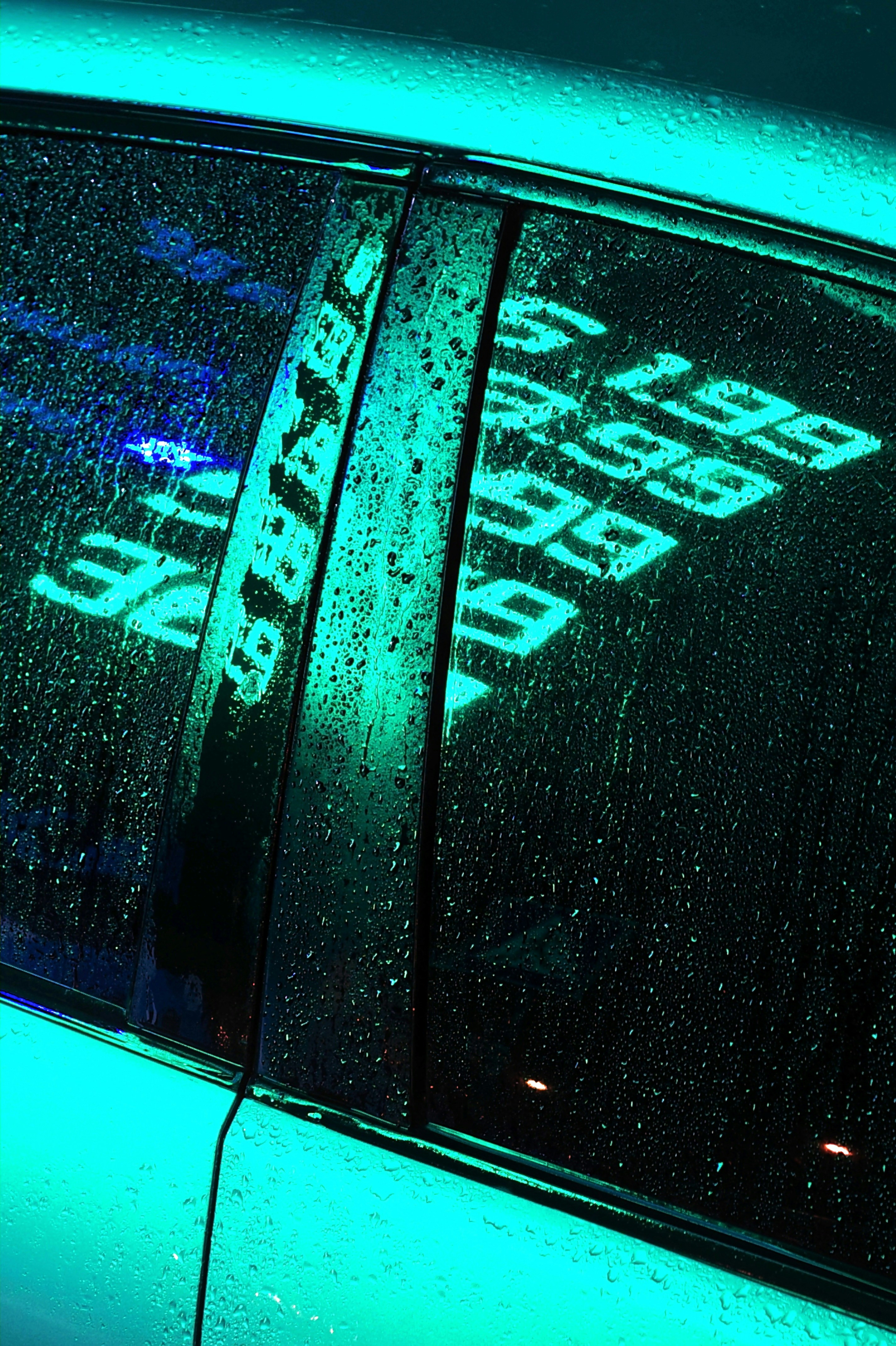 Neon numbers reflected on a wet car window. photo – Free Reflection ...