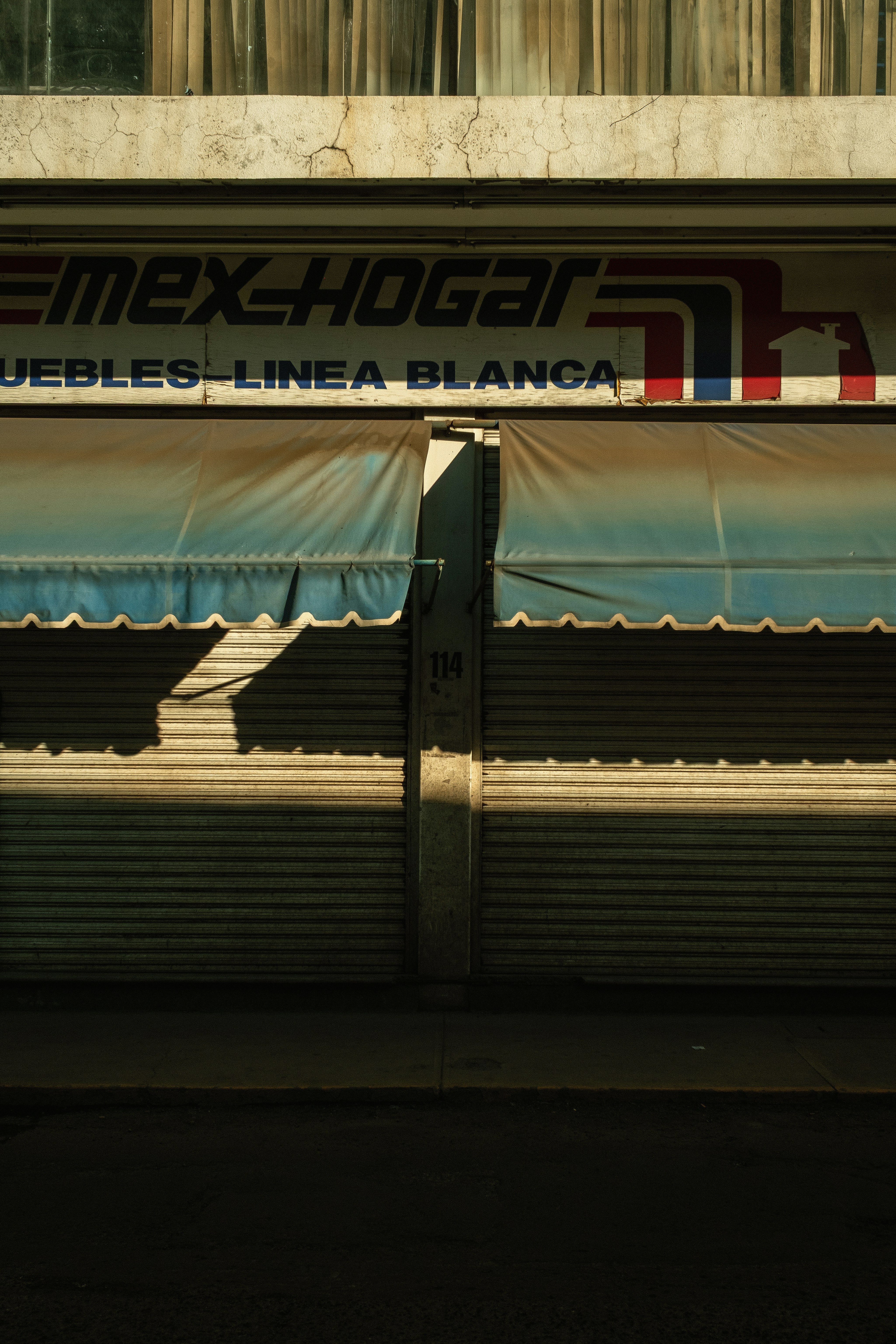 Closed storefront with awnings and metal shutters. photo – Free Street ...