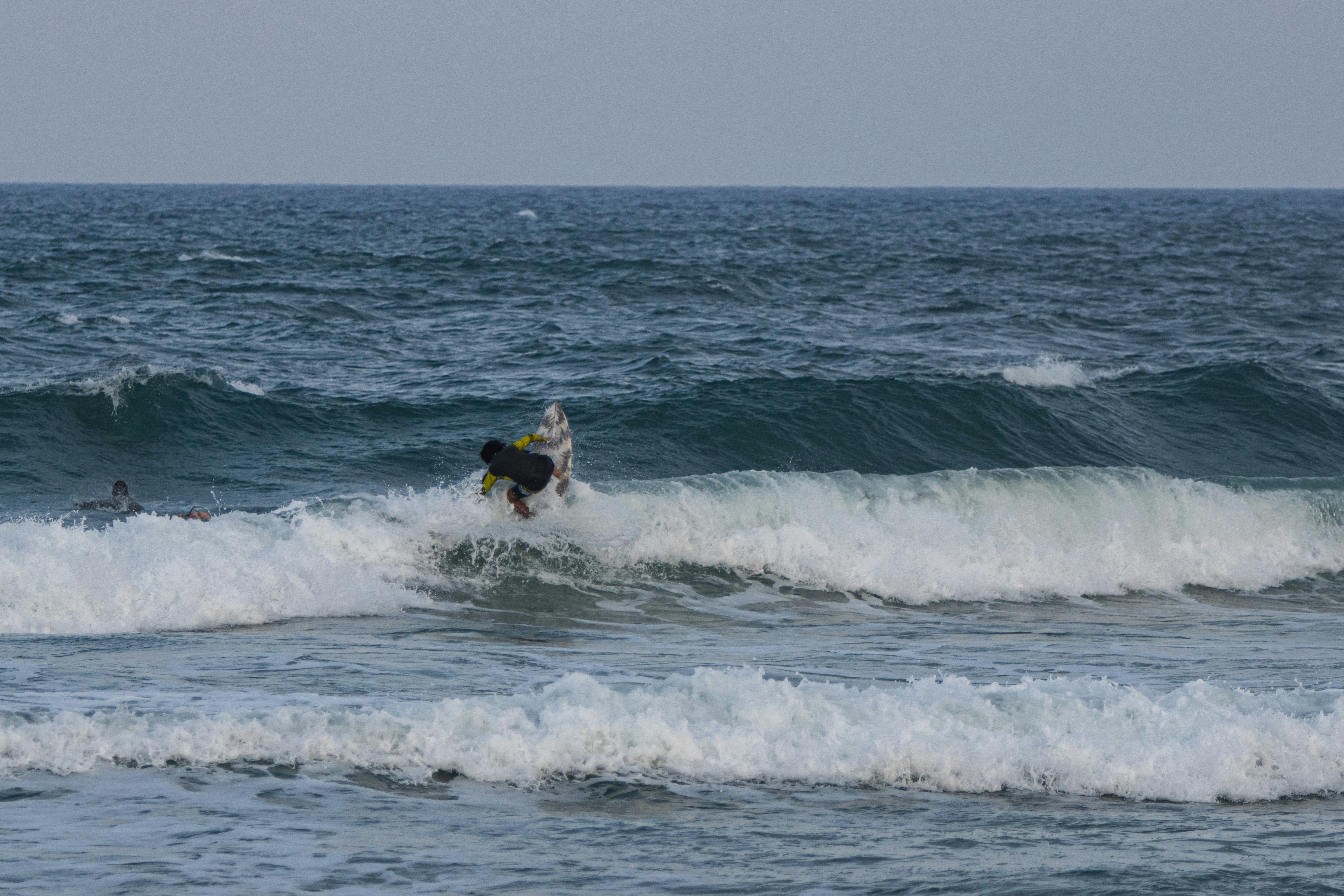 Carving the Atlantic Crest: A Lone Surfer Tackles a Rolling Break